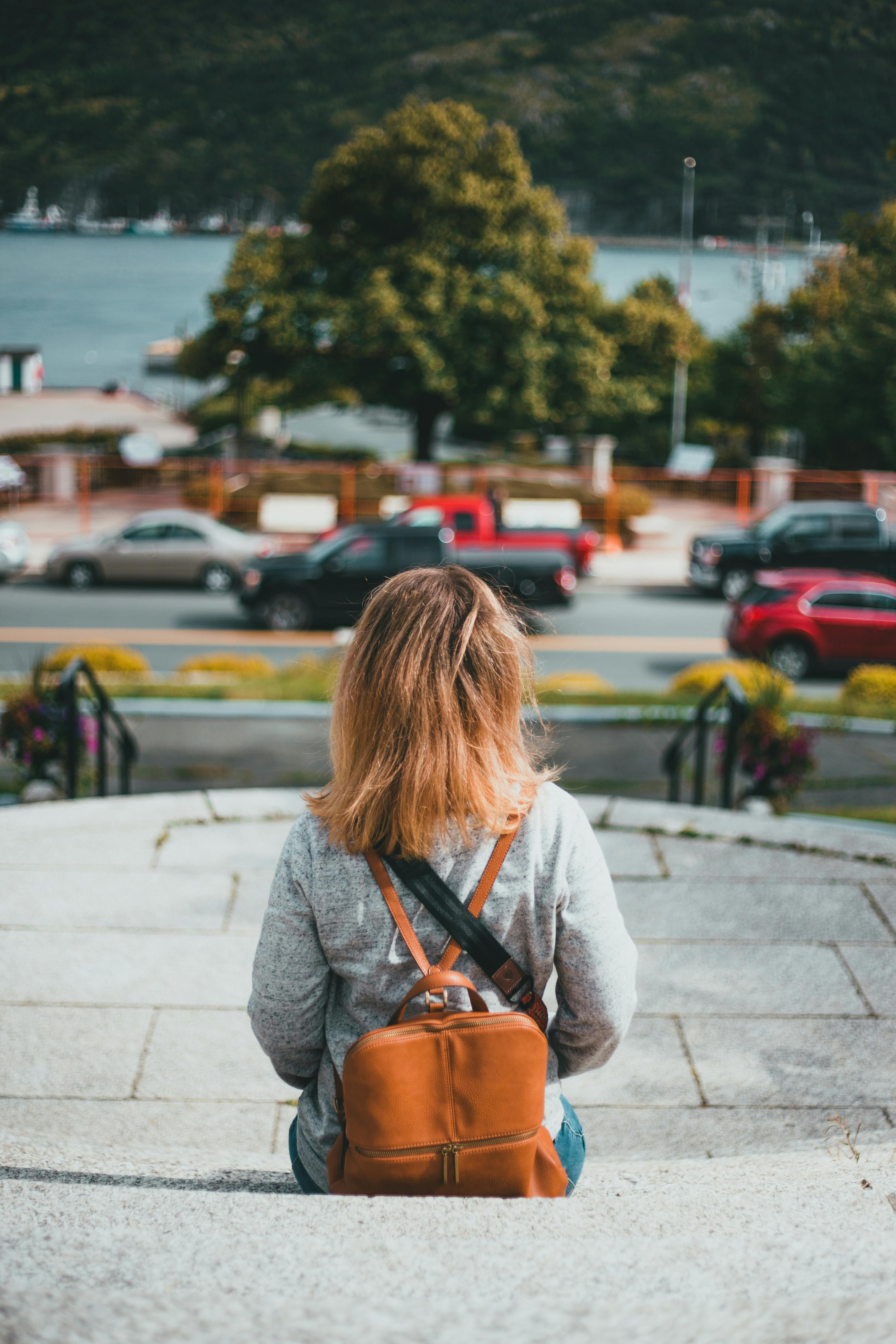 A Back View of a Woman Carrying Backpack · Free Stock Photo