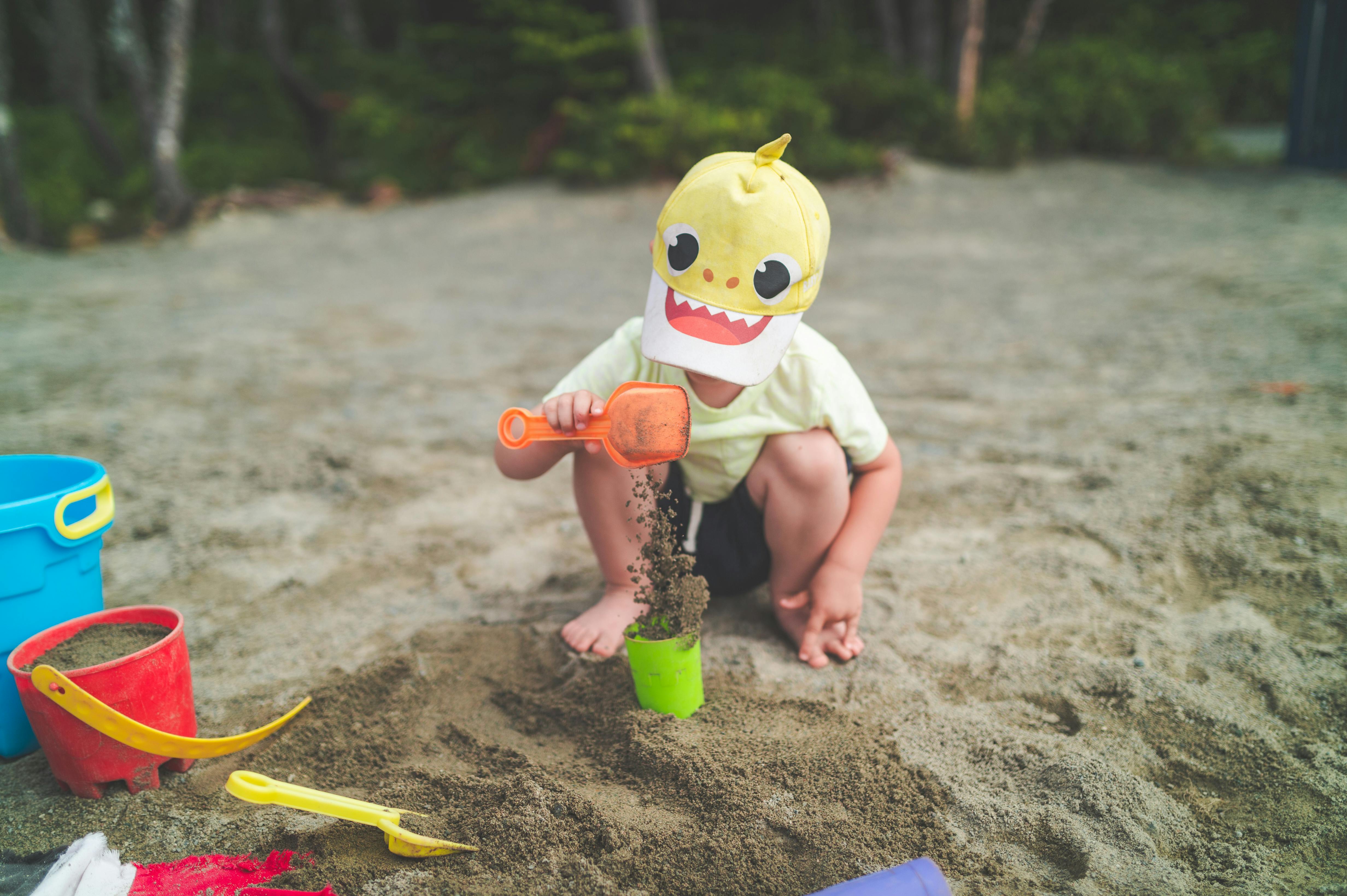 A Child Shoveling Sand · Free Stock Photo