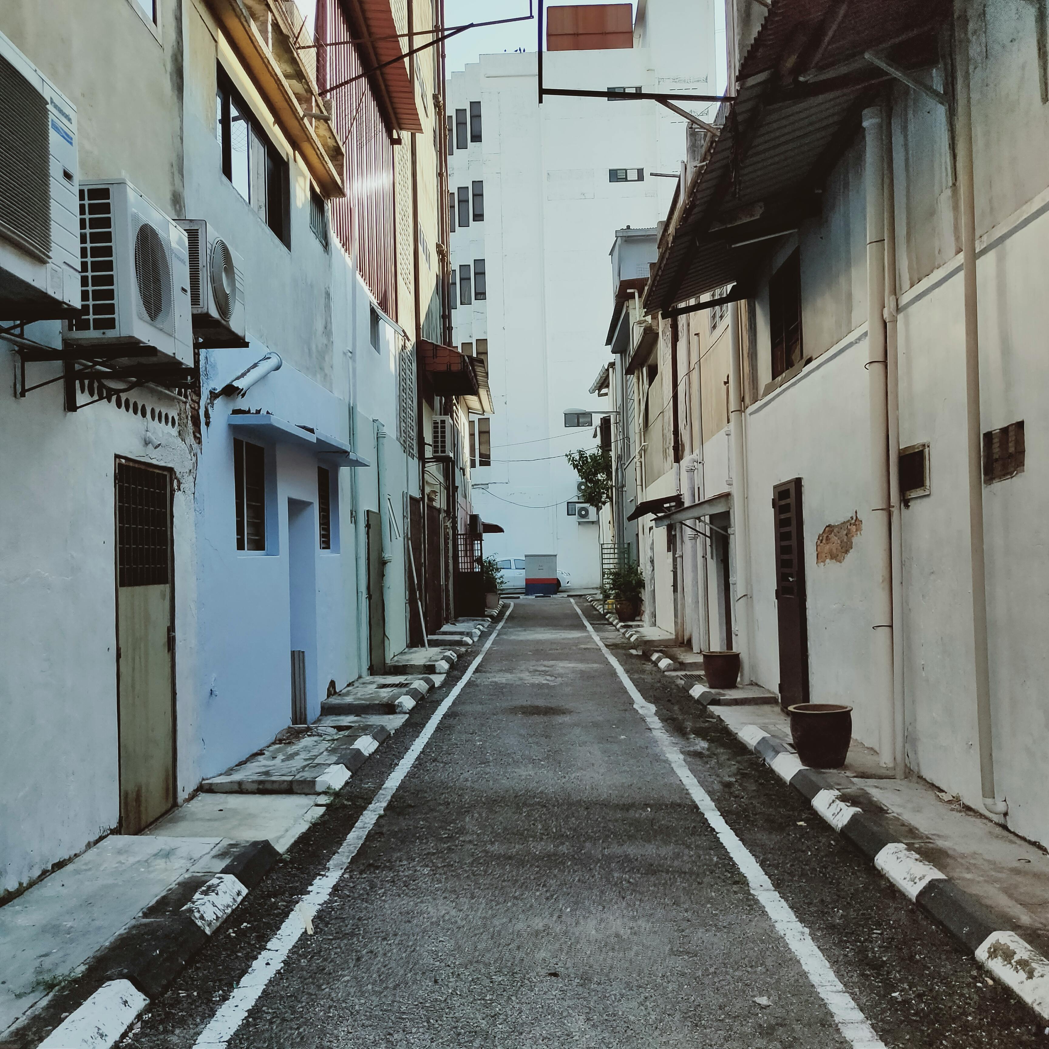 Empty Street Between Concrete Houses · Free Stock Photo
