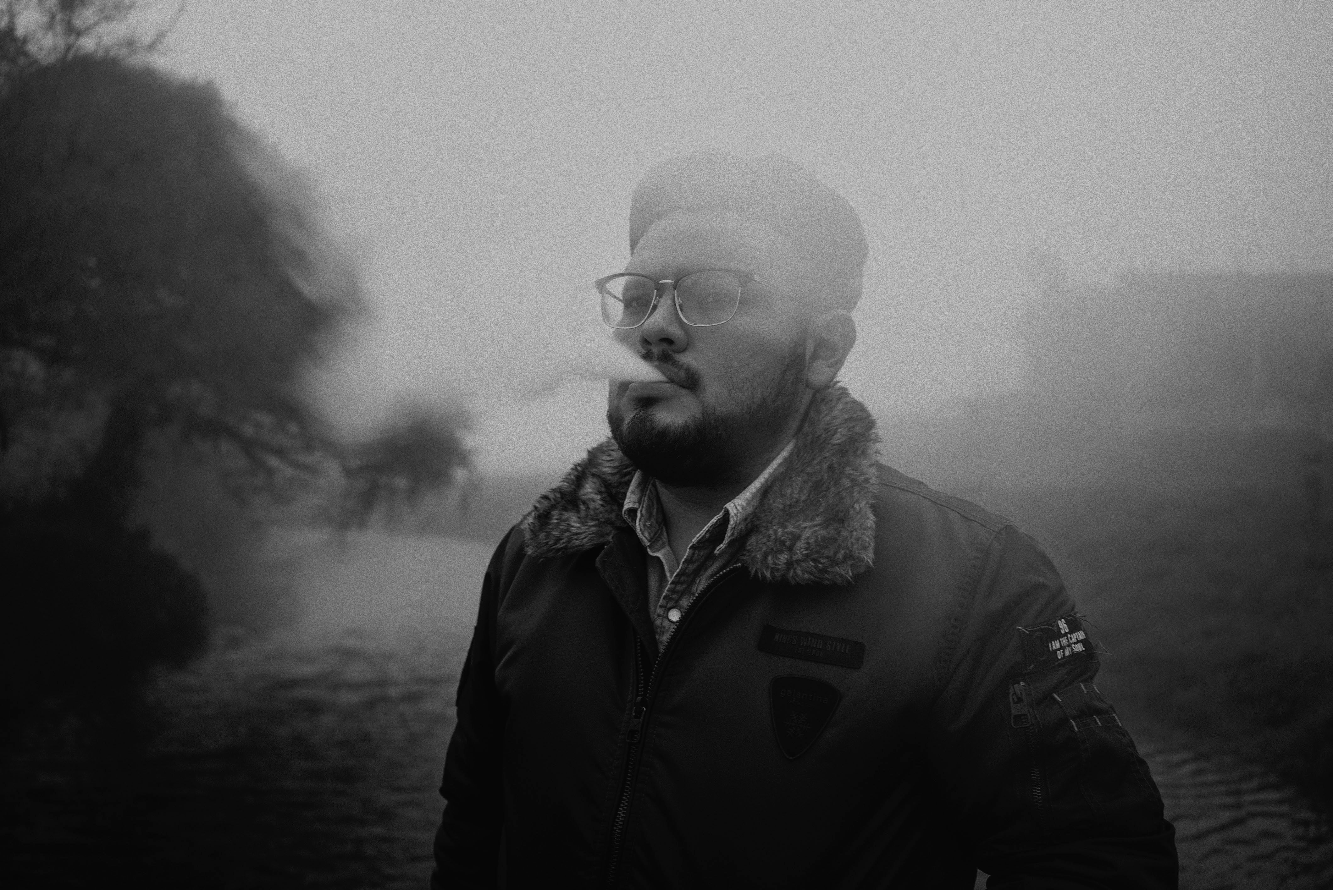 Grayscale Photography of Man Smoking Outdoors · Free Stock Photo