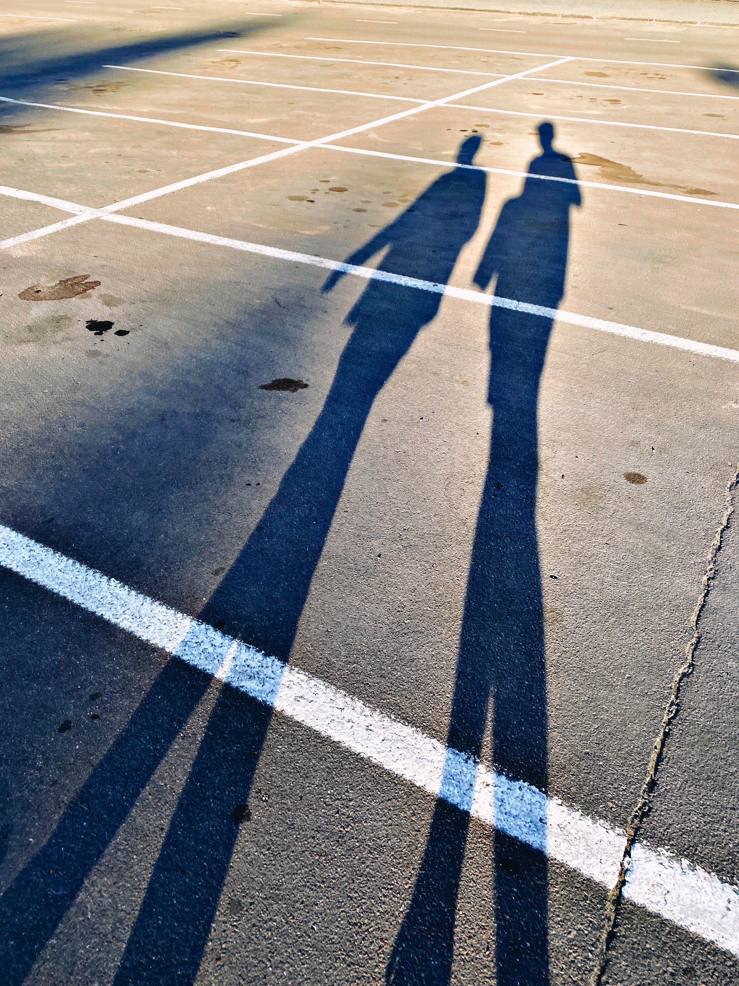 Shadows of People on Car Park · Free Stock Photo