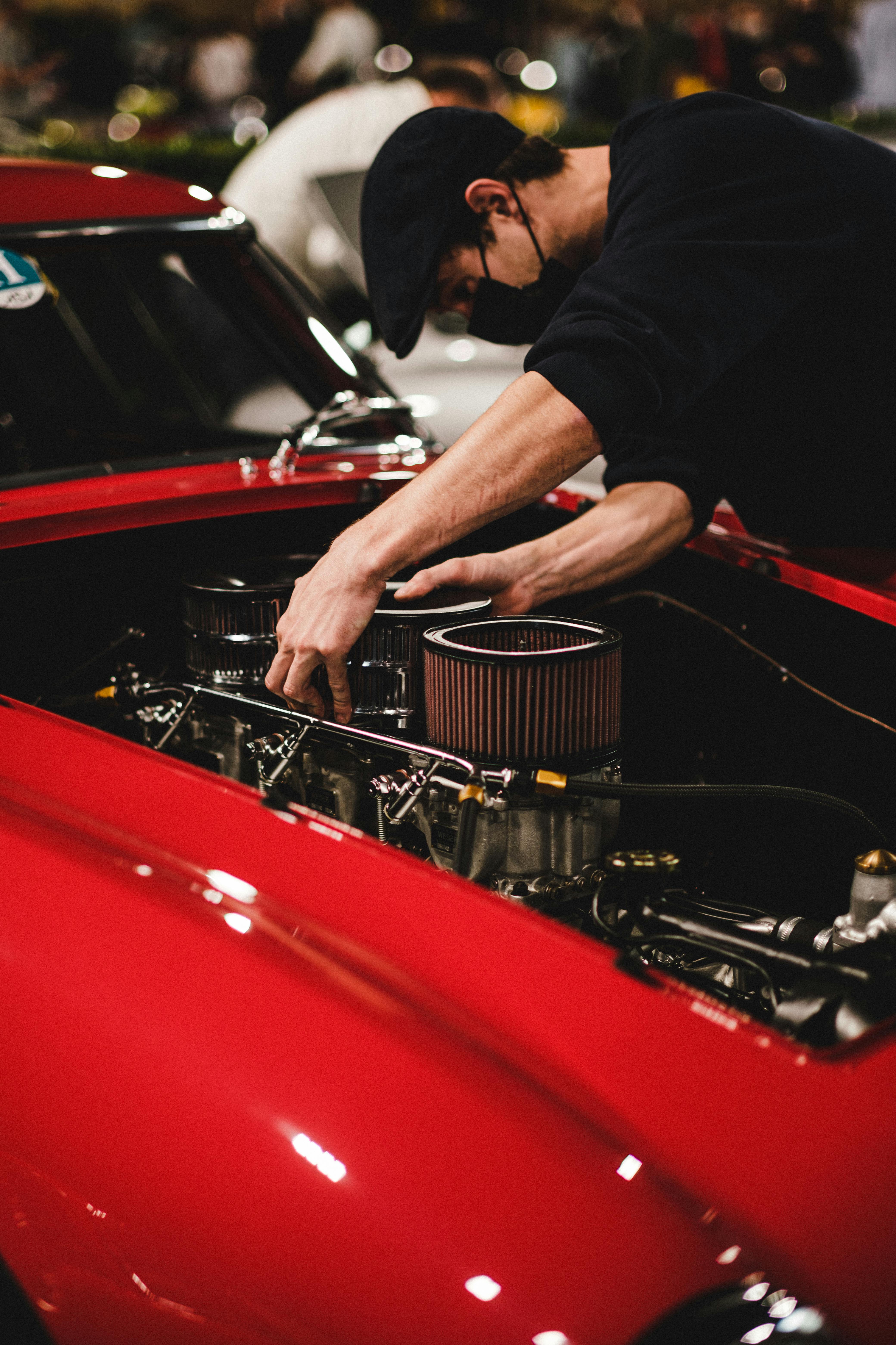 Man in Black Hat and Black Facemask Fixing the Engine of Car · Free ...