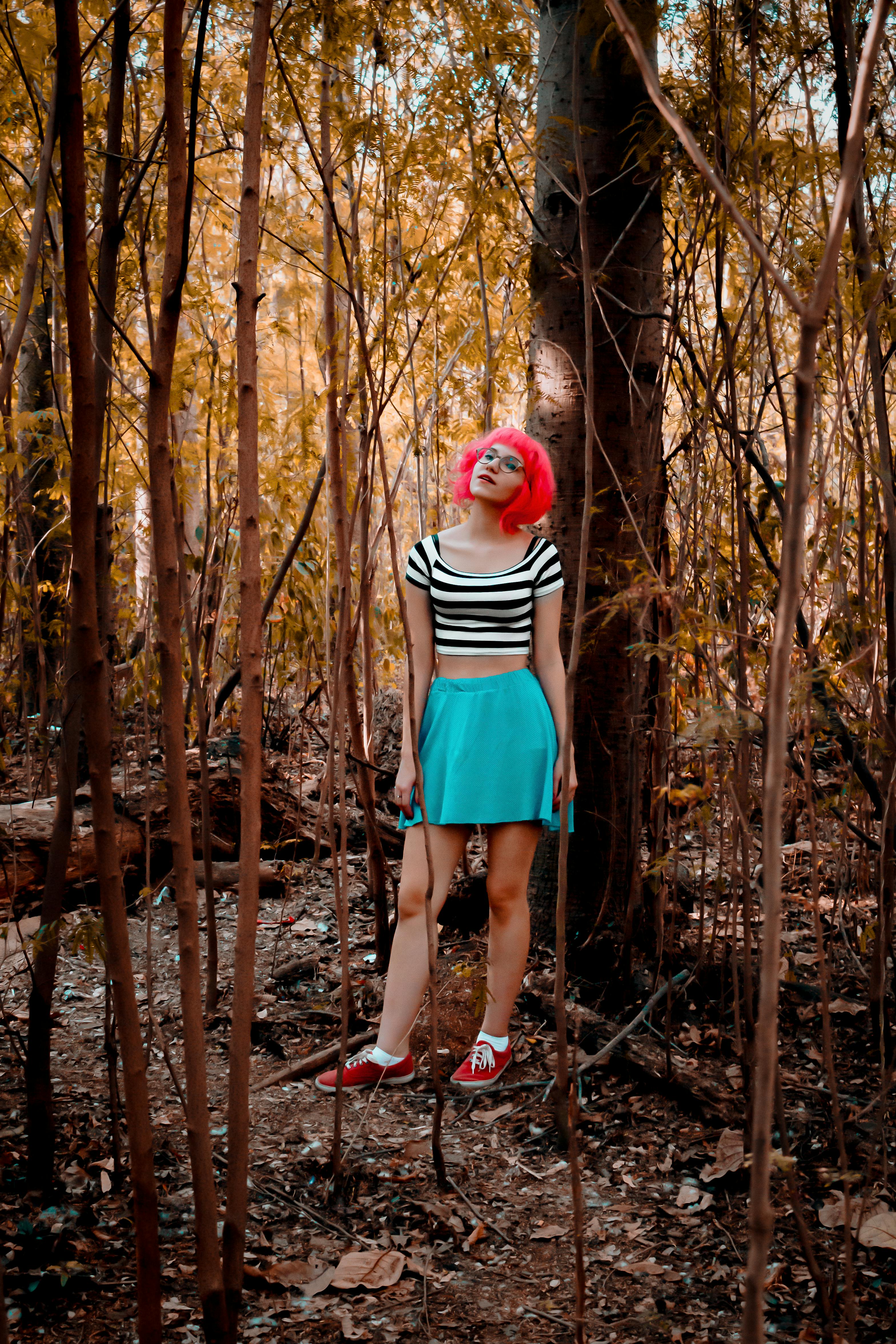 Woman in White and Black Stripe Shirt Beside the Trees · Free Stock Photo