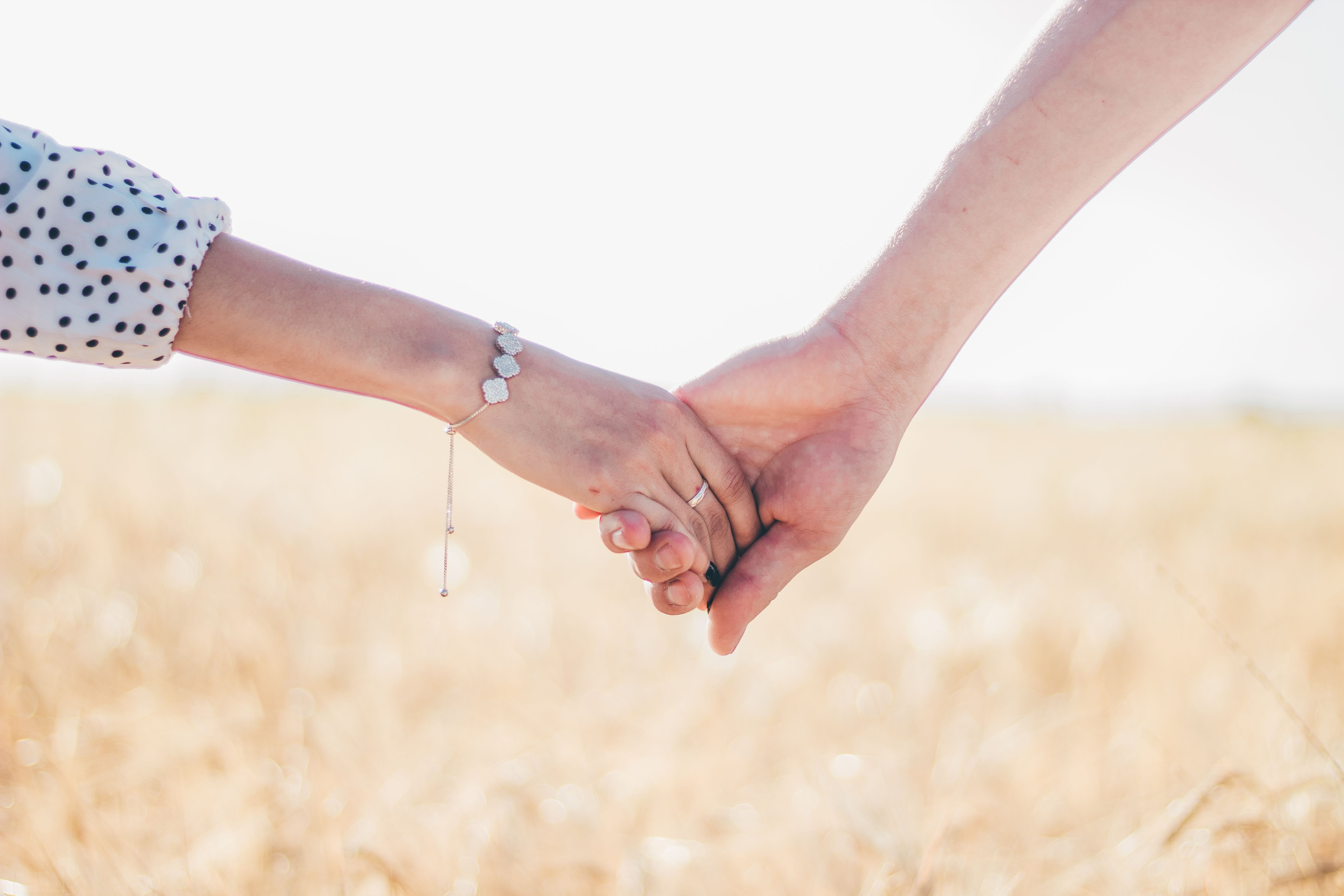 A Couple Holding Each Others Hand · Free Stock Photo