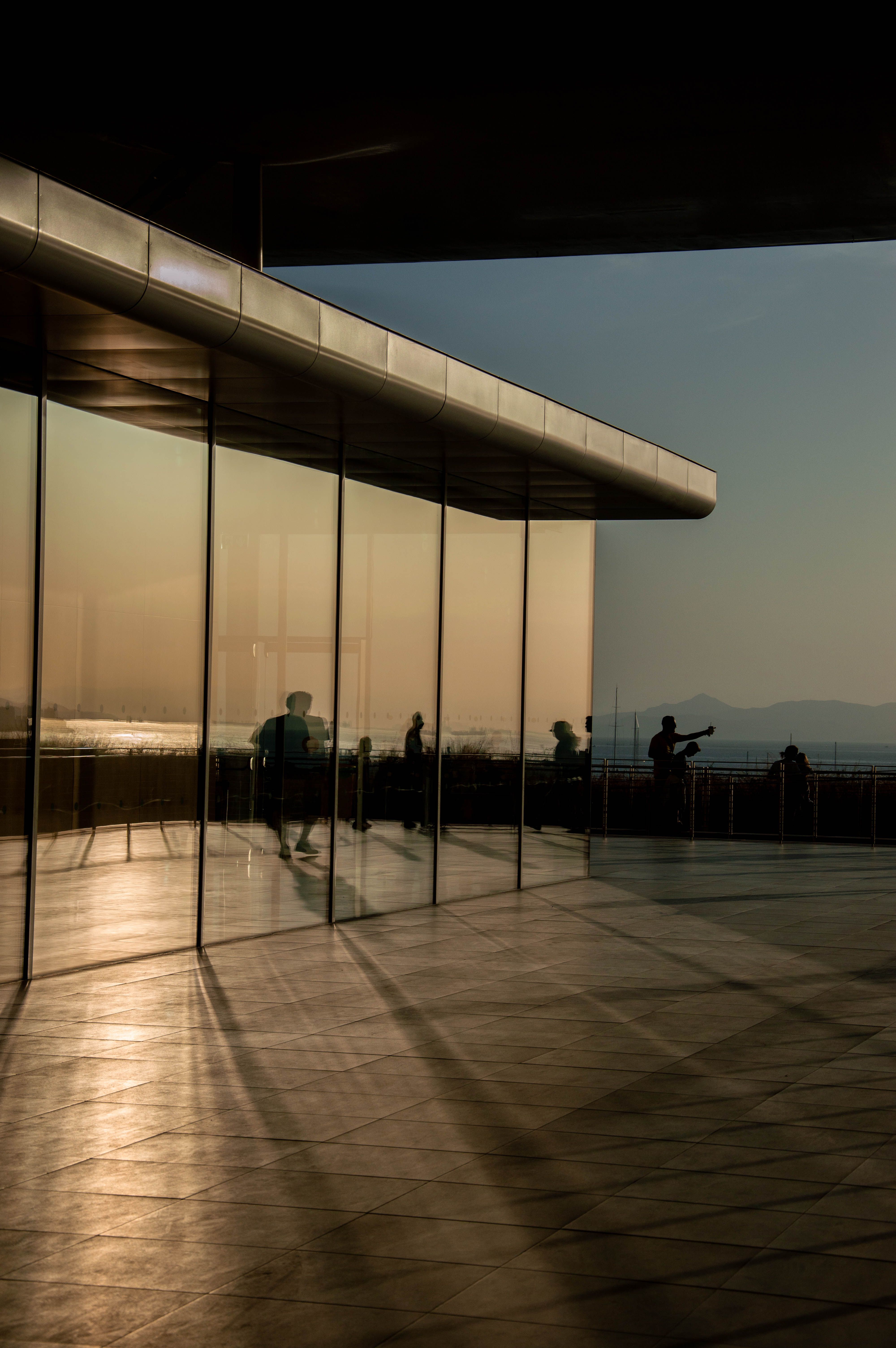 Reflections of People on Glass Panels · Free Stock Photo