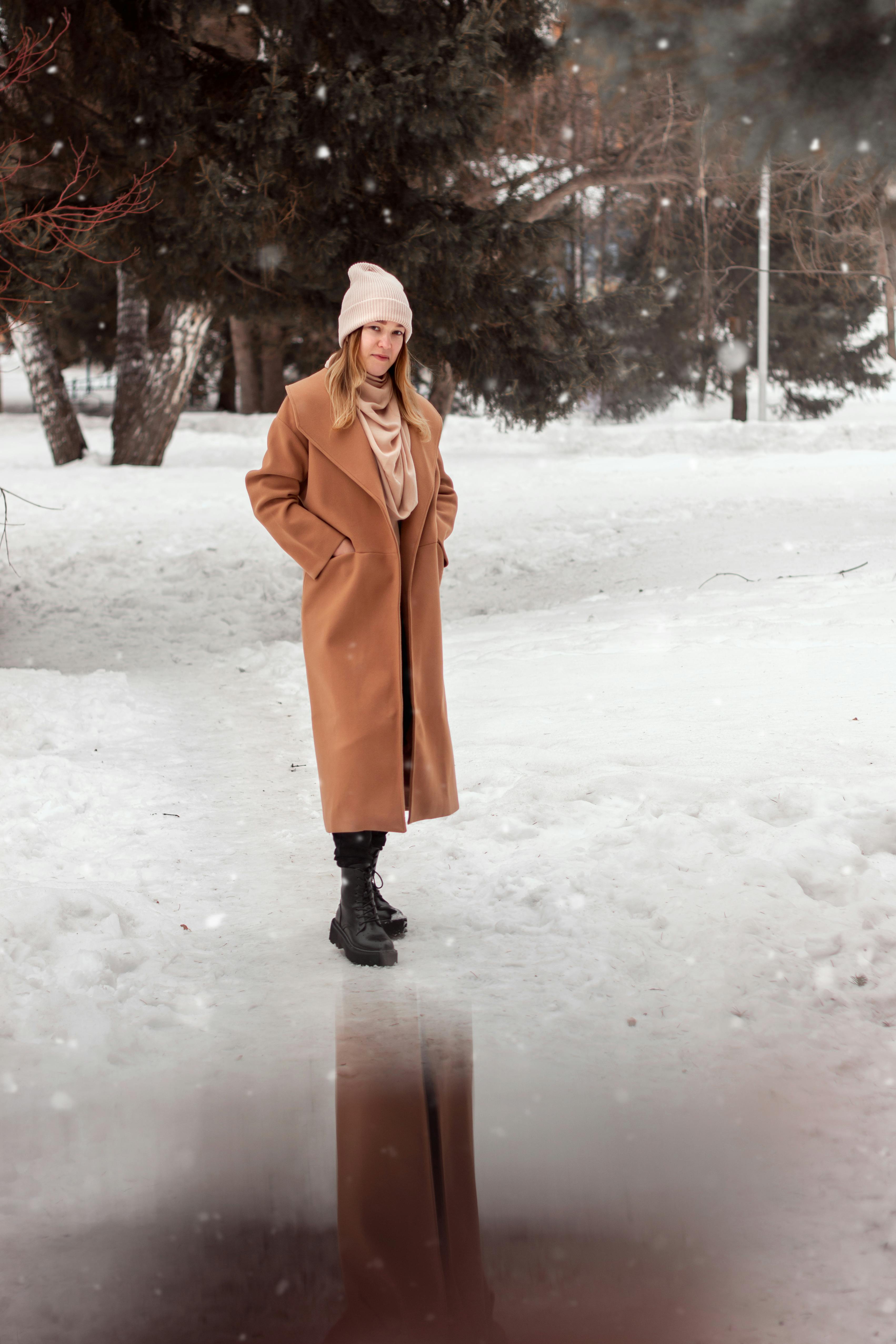 Woman in Brown Coat Standing on Snow Covered Ground · Free Stock Photo