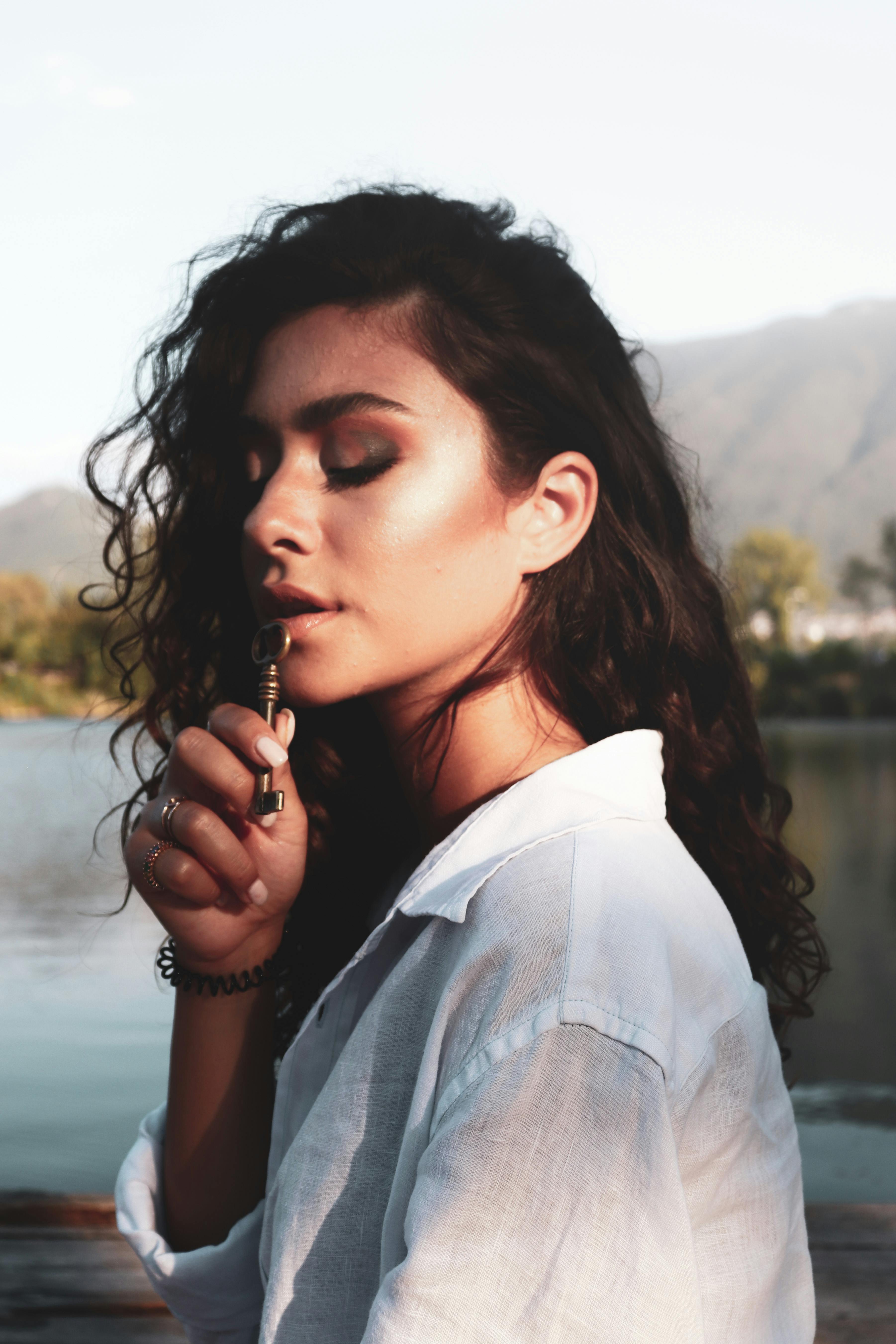 A Woman Holding a Key · Free Stock Photo