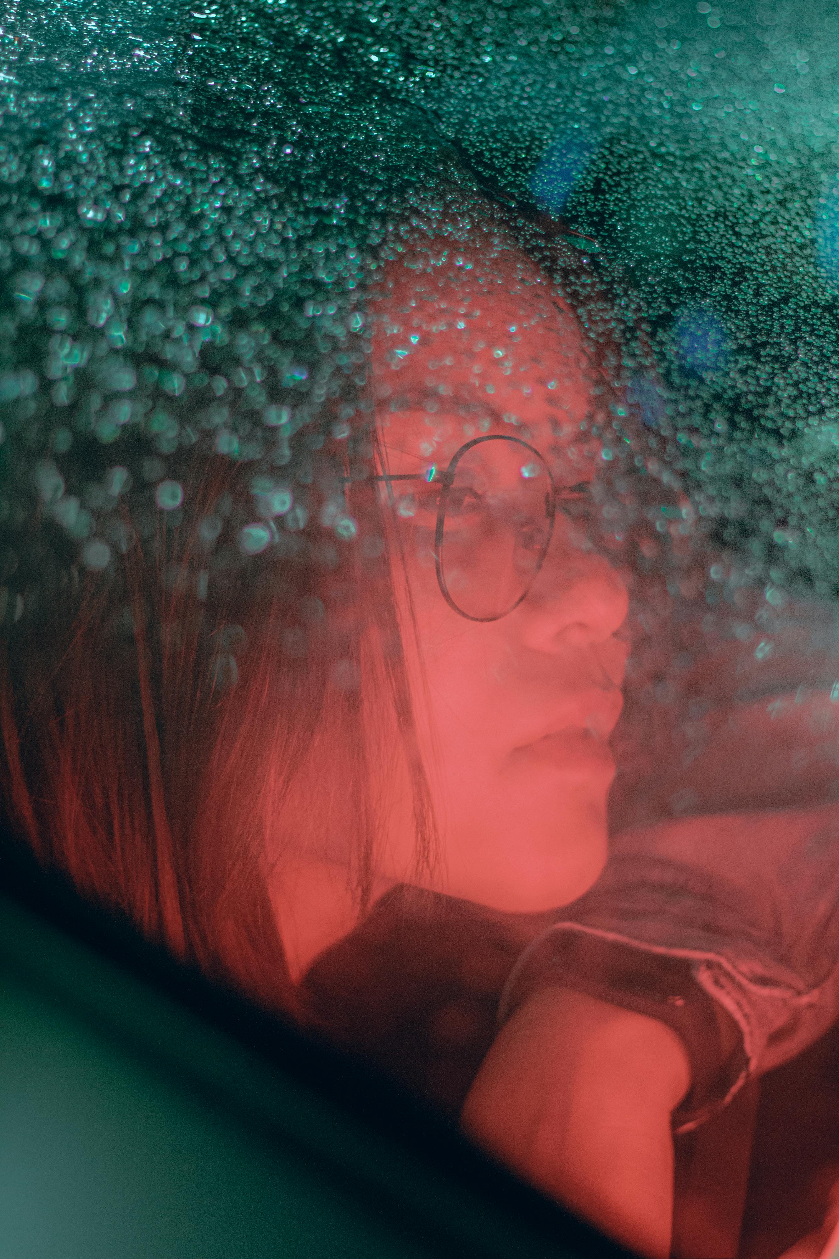 Portrait of a Woman Illuminated by a Red Light Behind Glass · Free ...