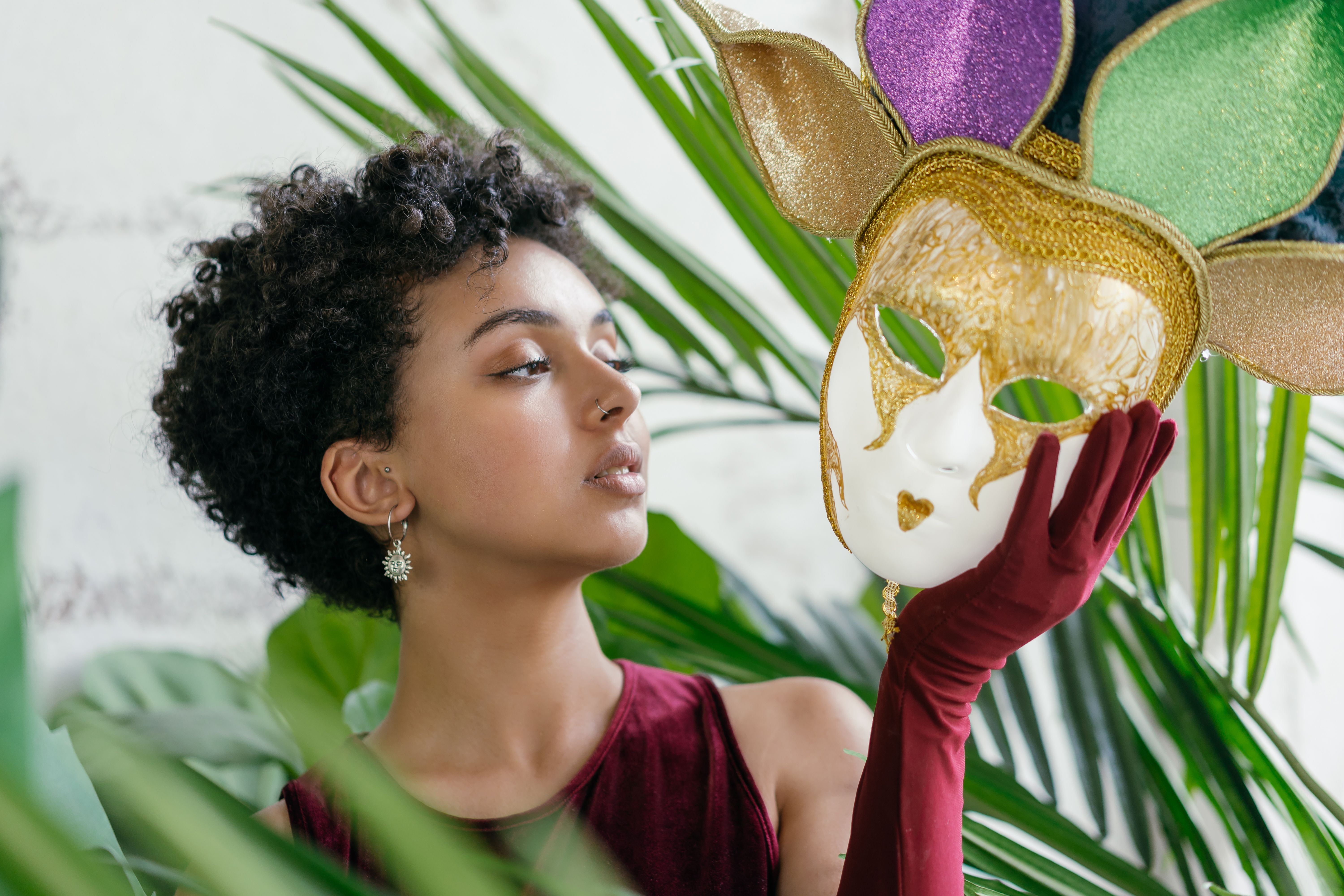 Woman with Curly Hair Holding a Mask · Free Stock Photo