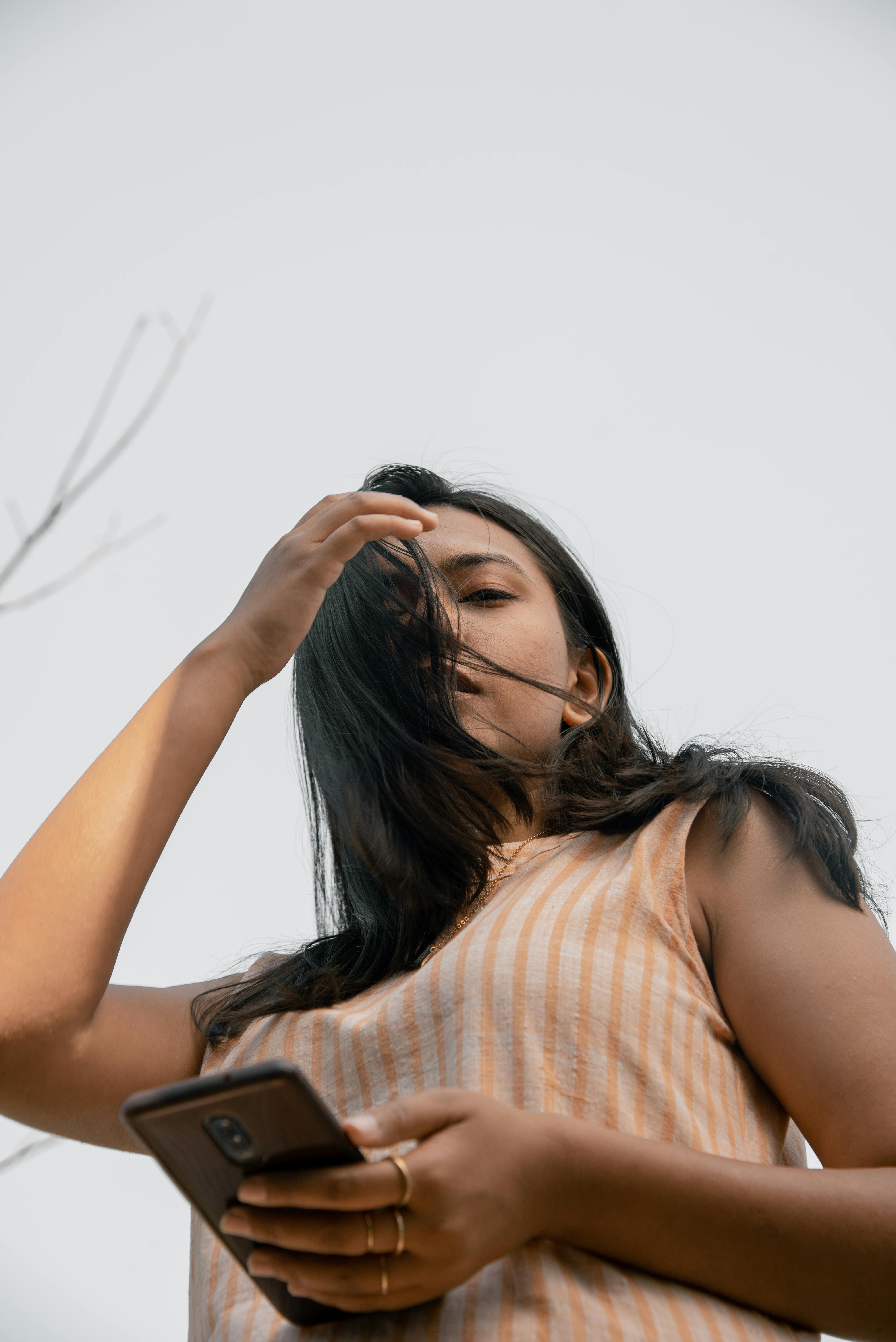 Woman Holding a Mobile Phone · Free Stock Photo