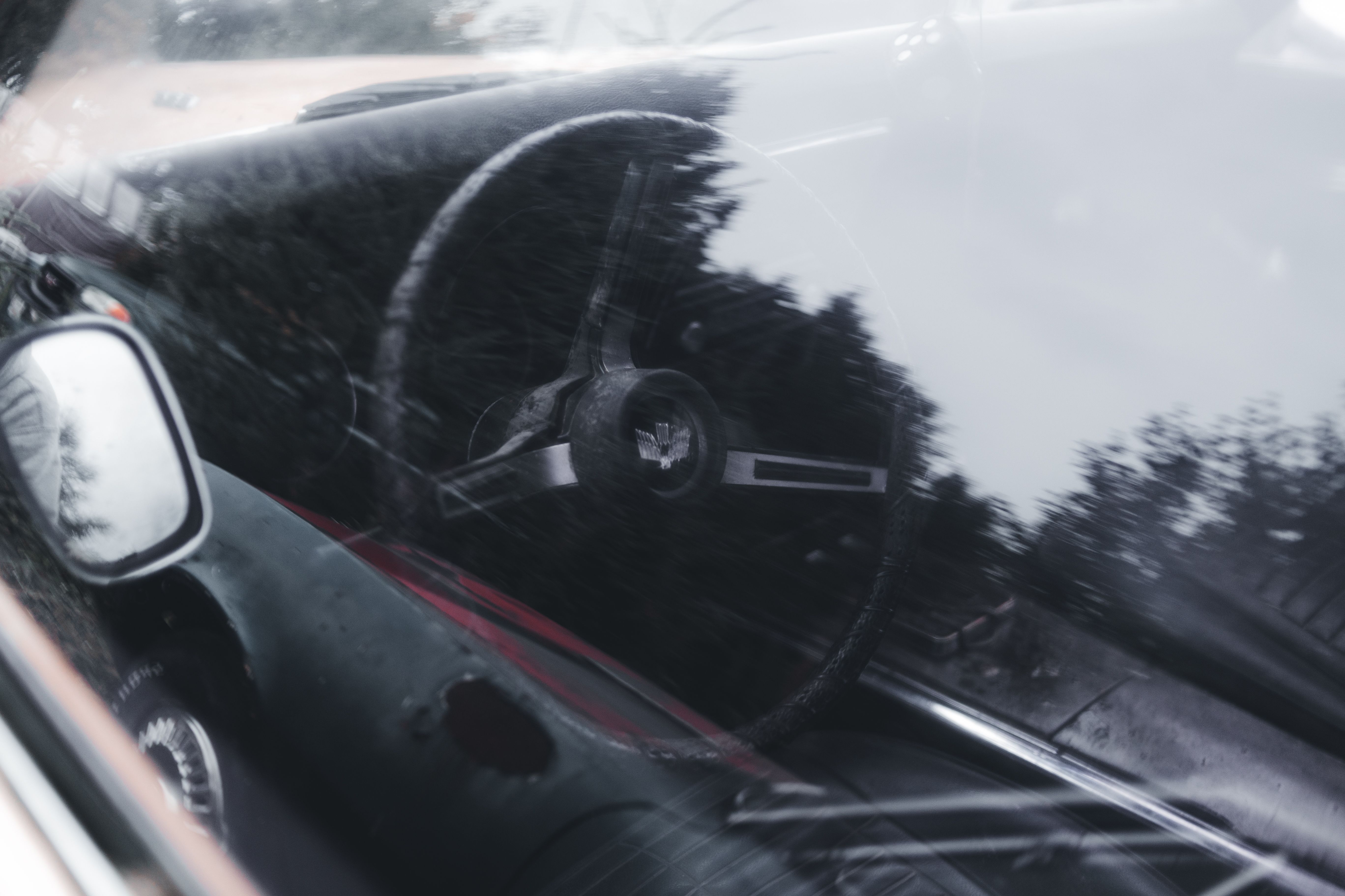 Steering Wheel Seen Through Car Window · Free Stock Photo