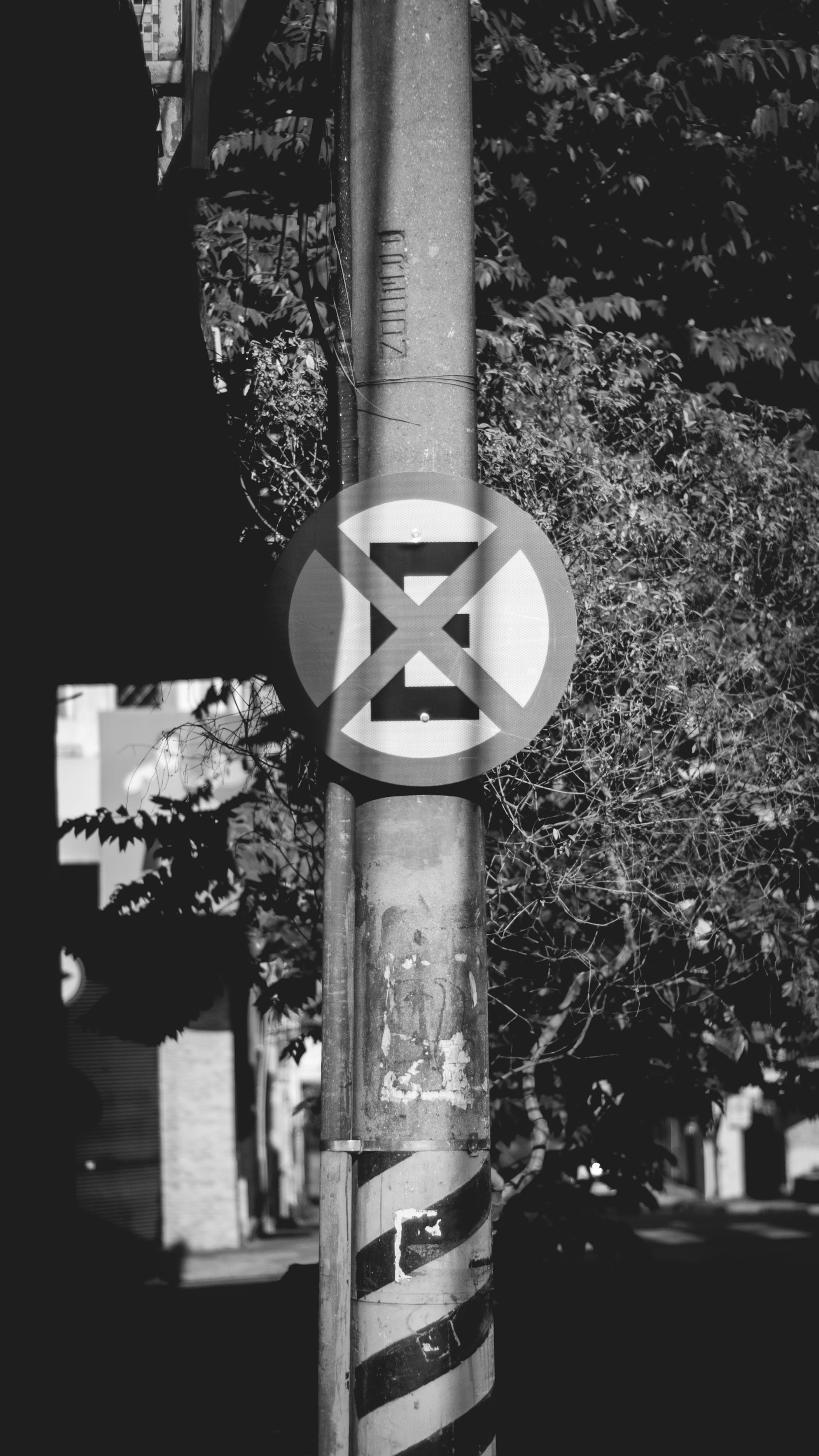 Grayscale Photo of a No Standing Street Sign Posted on a Concrete Pole ...
