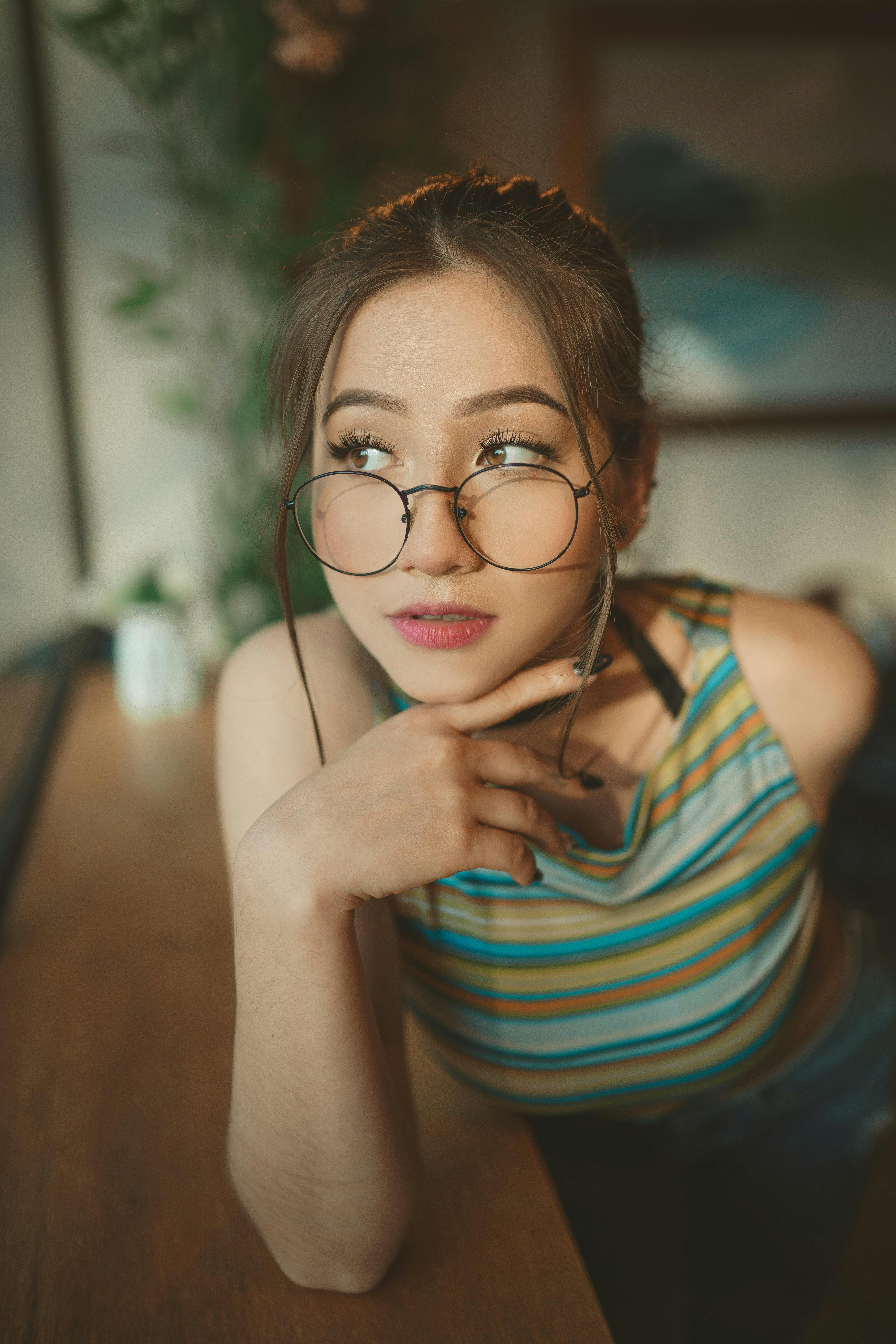 A Woman in Stripes Tank Top Wearing Eyeglasses · Free Stock Photo