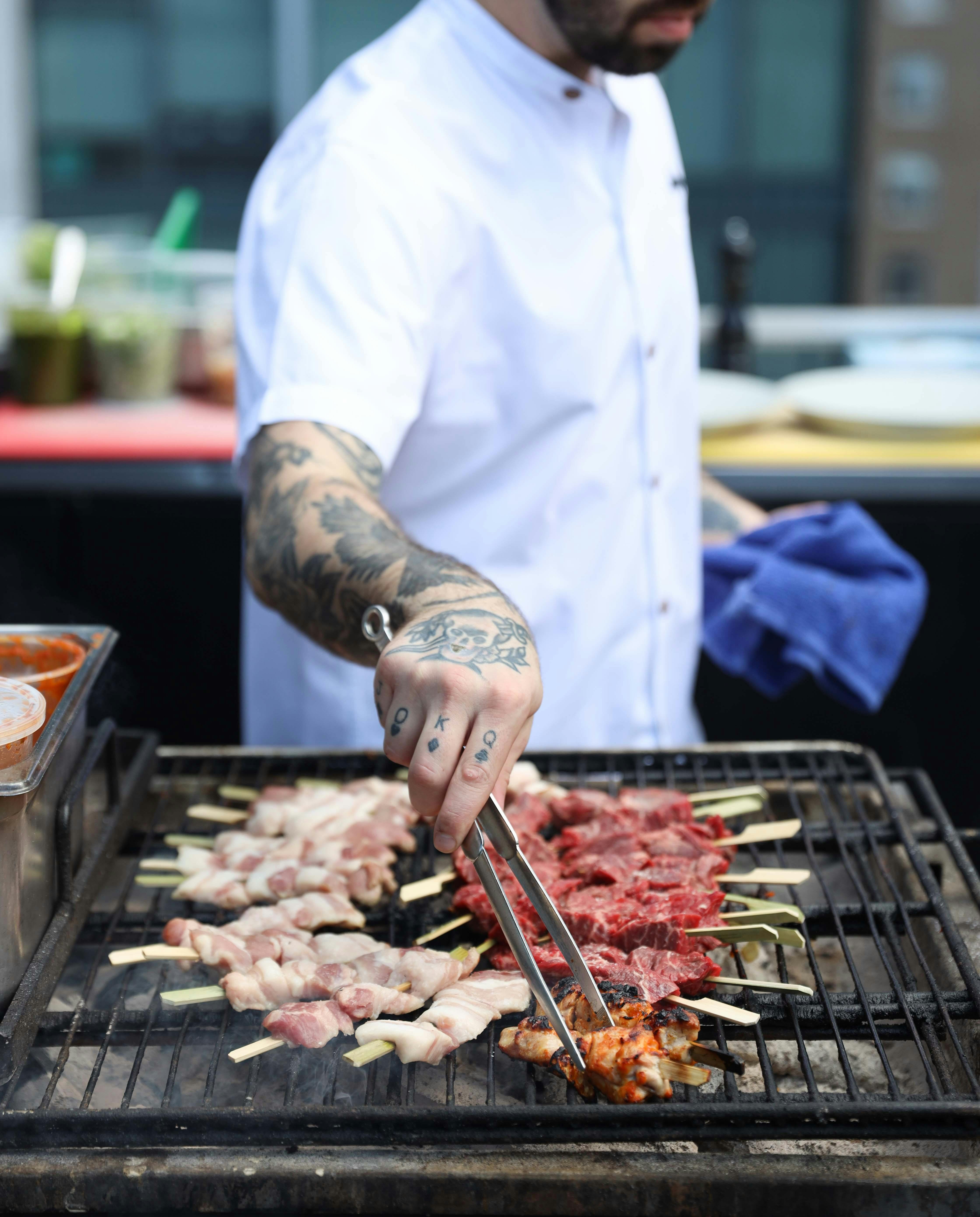 A Man Wearing a White uniform Coking Barbecue · Free Stock Photo
