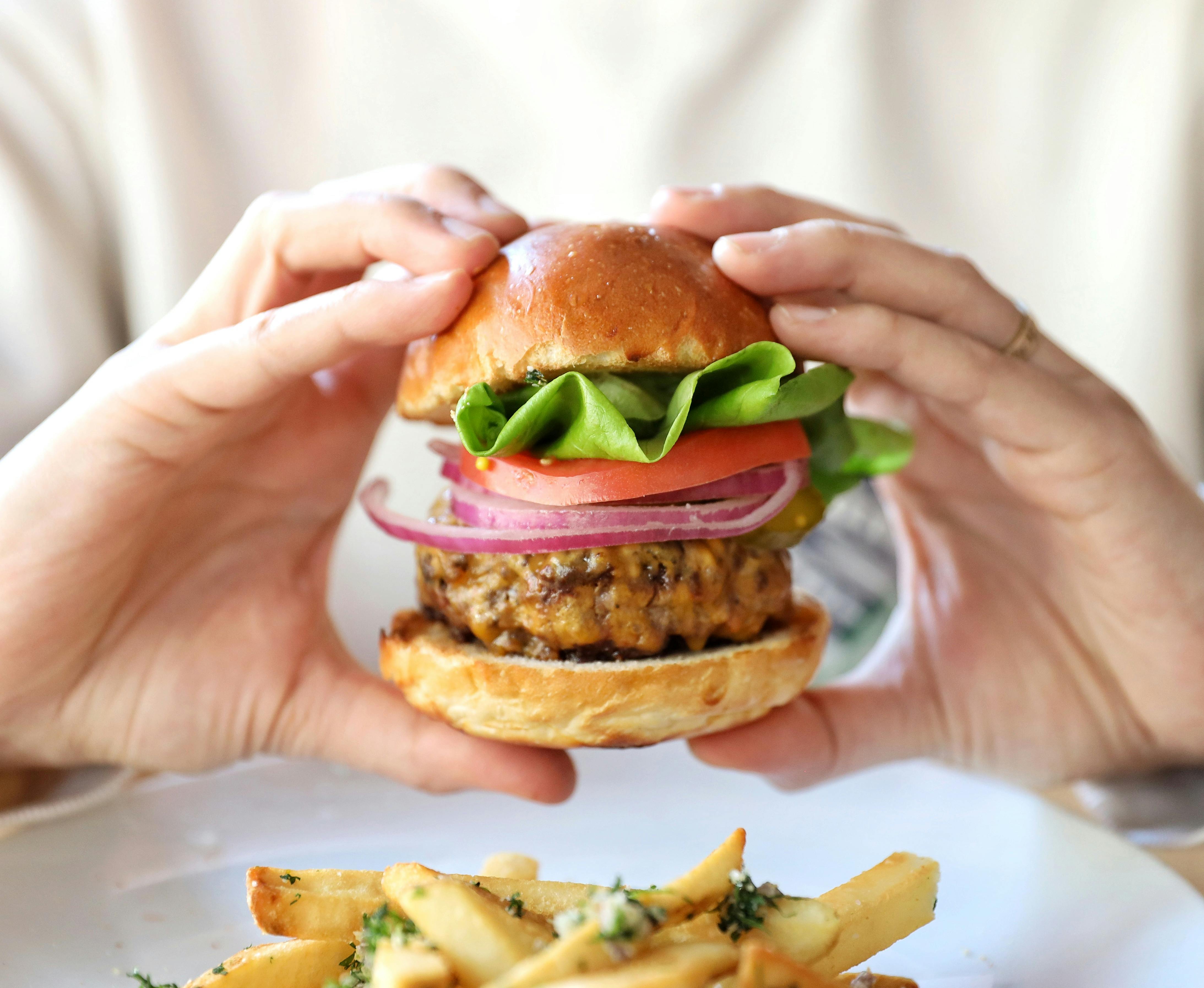 A Person Holding a Burger · Free Stock Photo