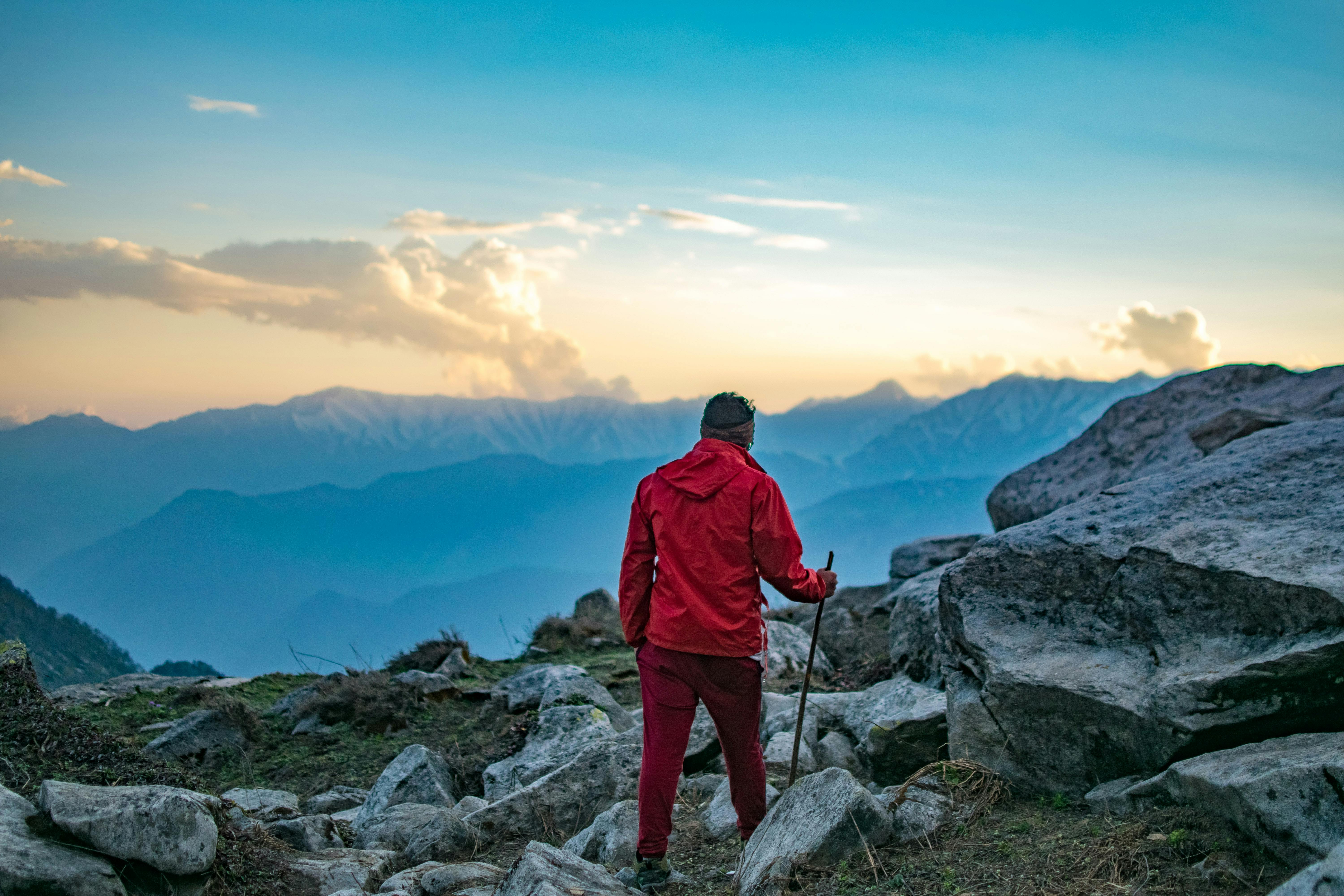 Silhouette of a Man Standing on a Mountain · Free Stock Photo