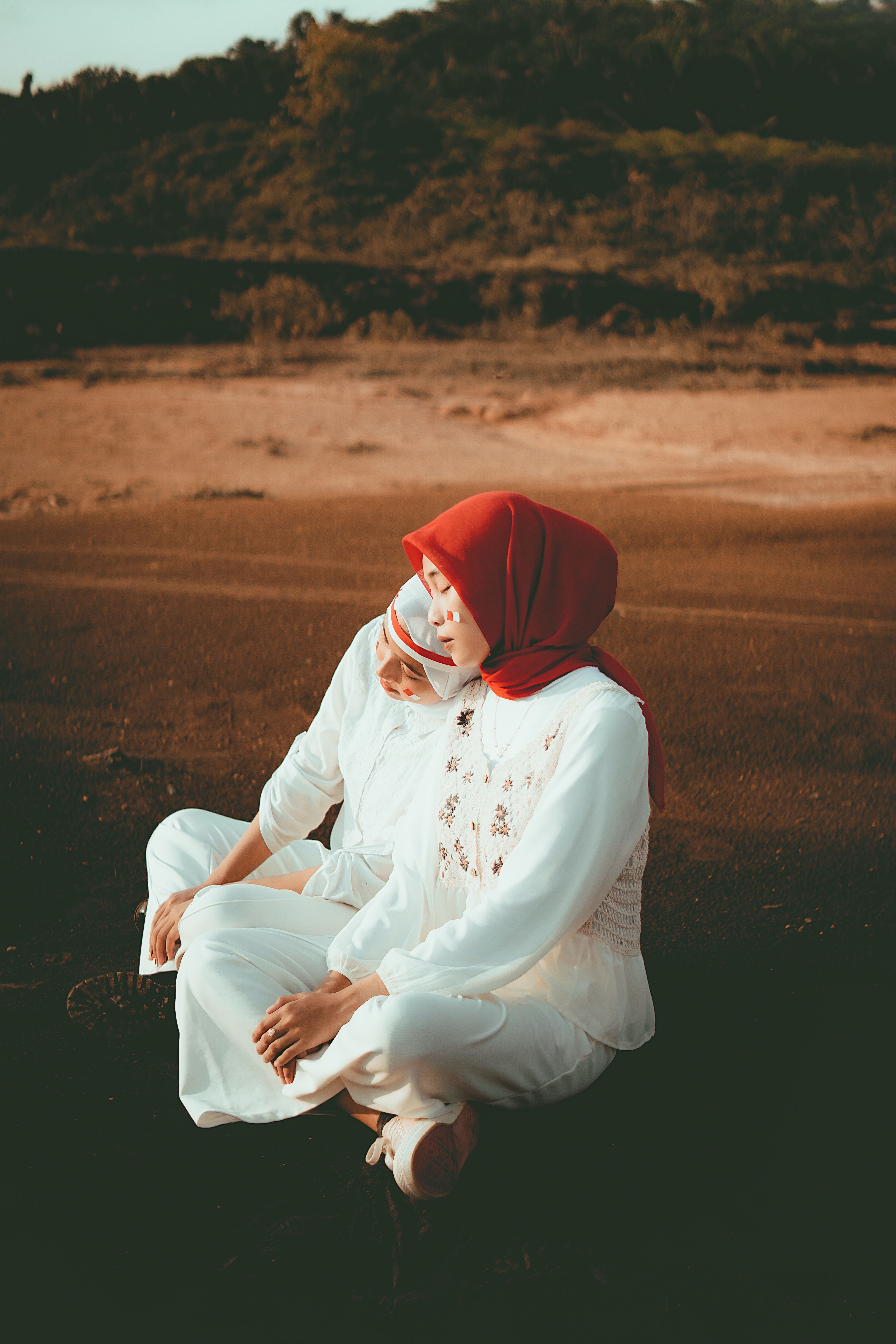 Hijabi Woman Sitting on Chair in Roof Garden · Free Stock Photo