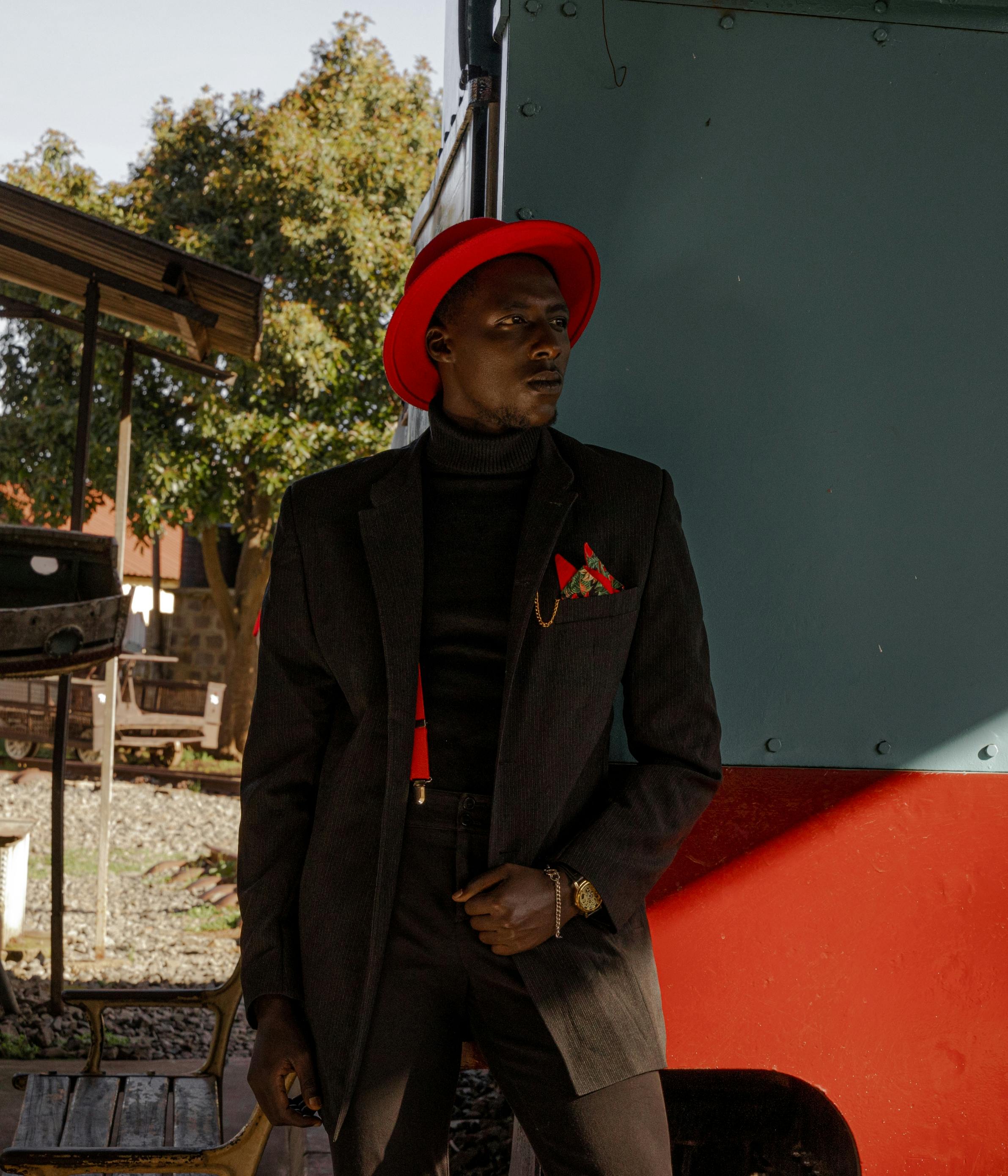 Man in Black Suit Wearing Red Hat · Free Stock Photo