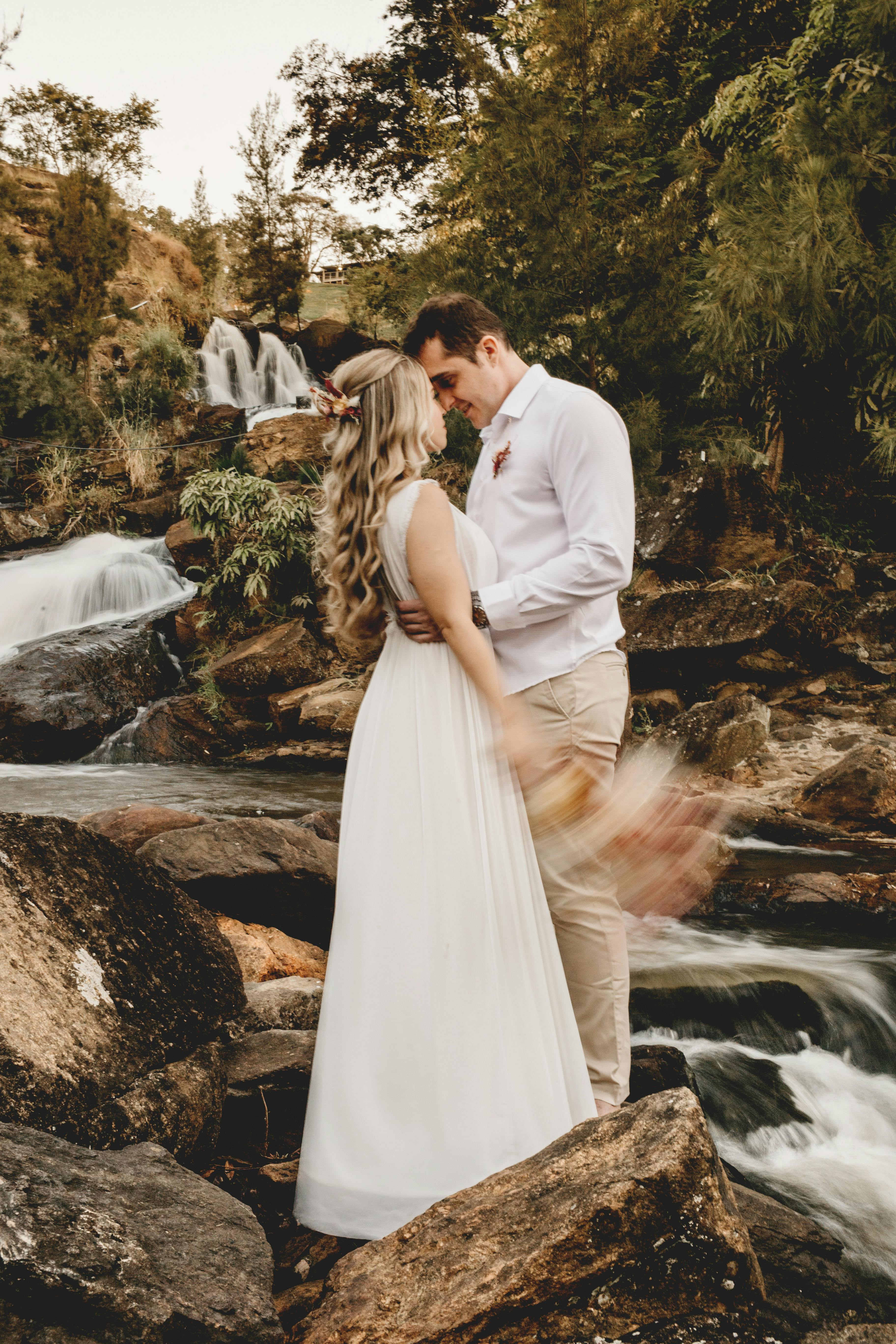 Portrait of Couple Kissing by Waterfall · Free Stock Photo