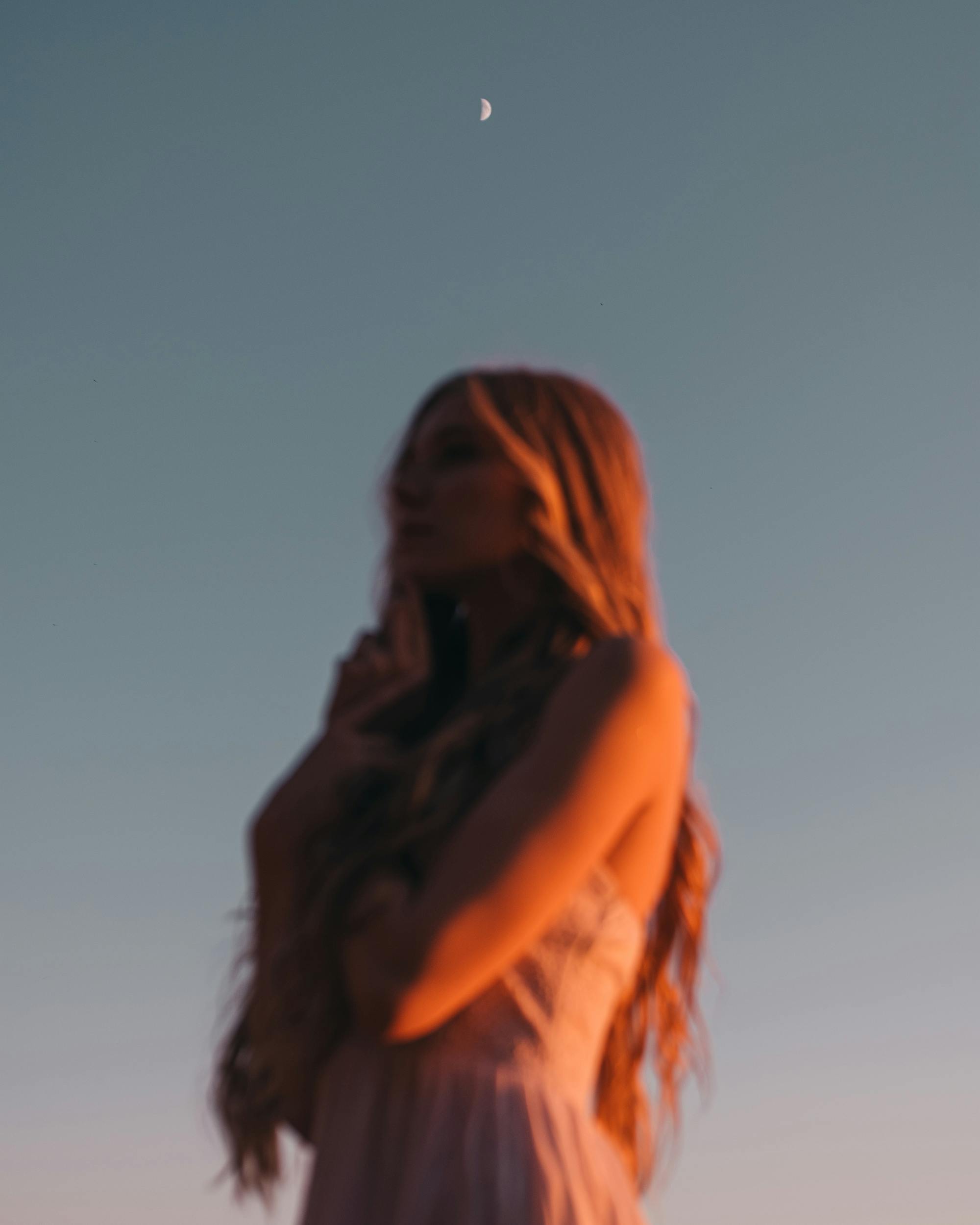 A Woman Standing Under Blue Sky with Half Moon · Free Stock Photo