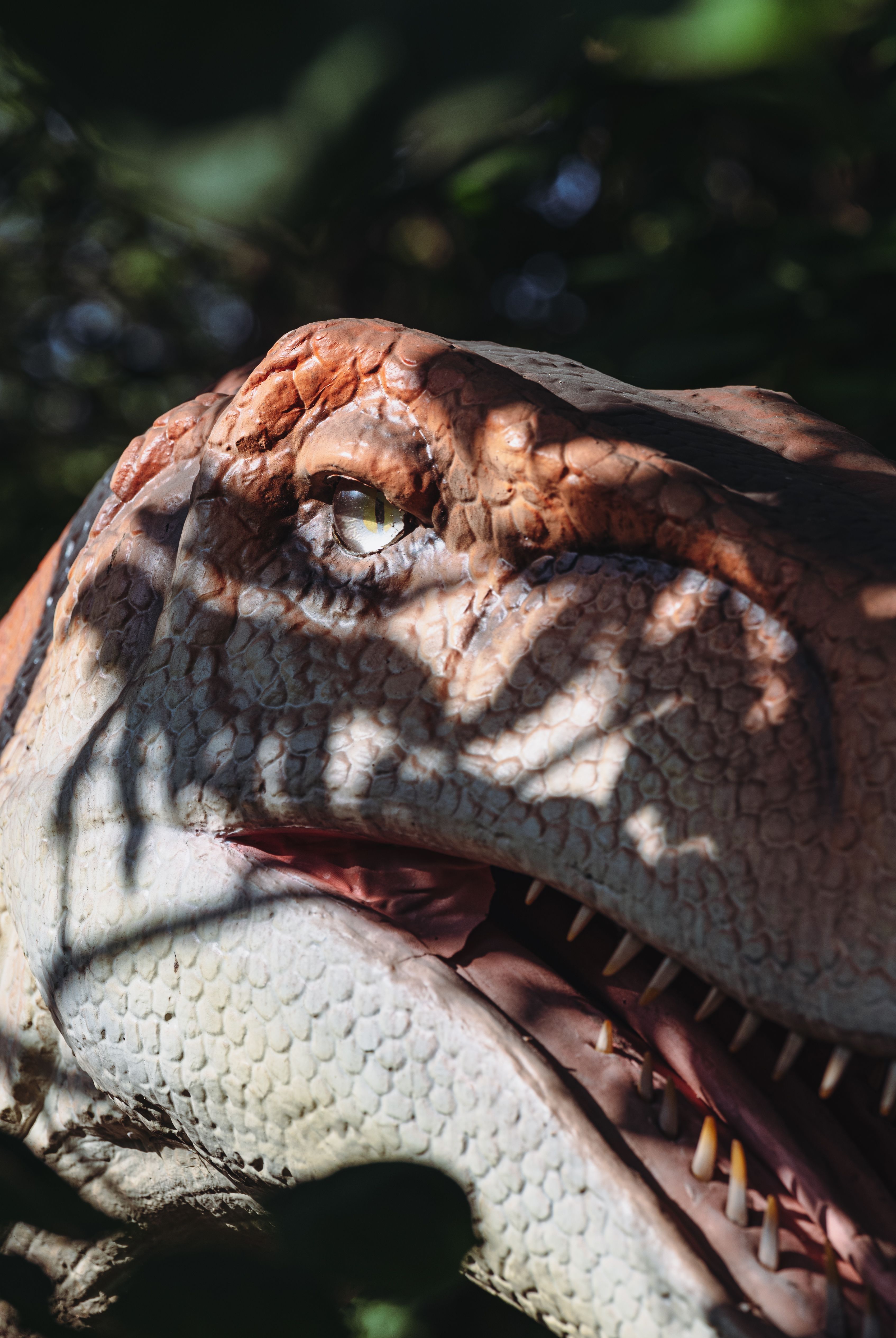 Brown Dinosaur Beside Green Tree · Free Stock Photo