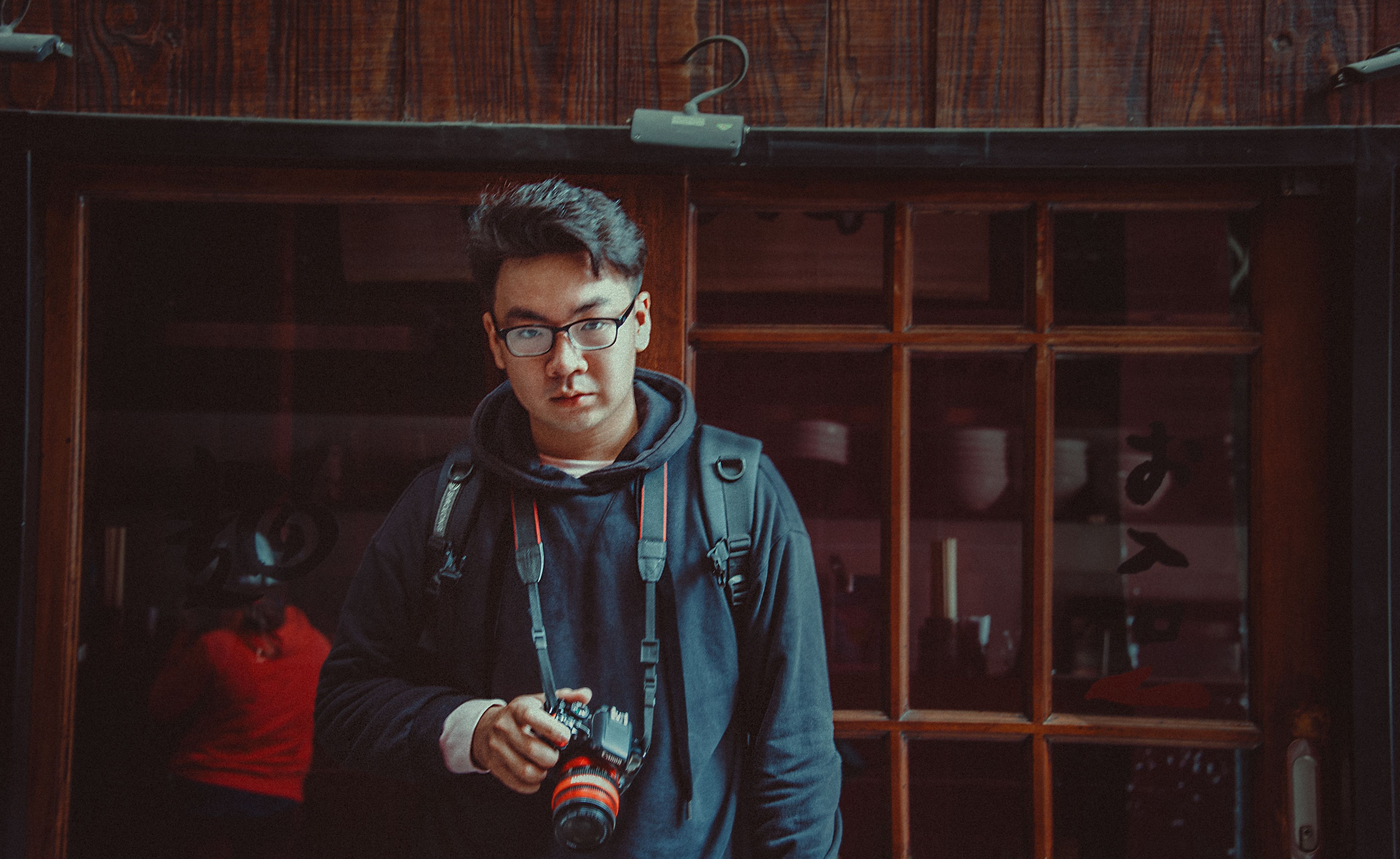Man Wearing Jacket Holding Dslr Camera · Free Stock Photo