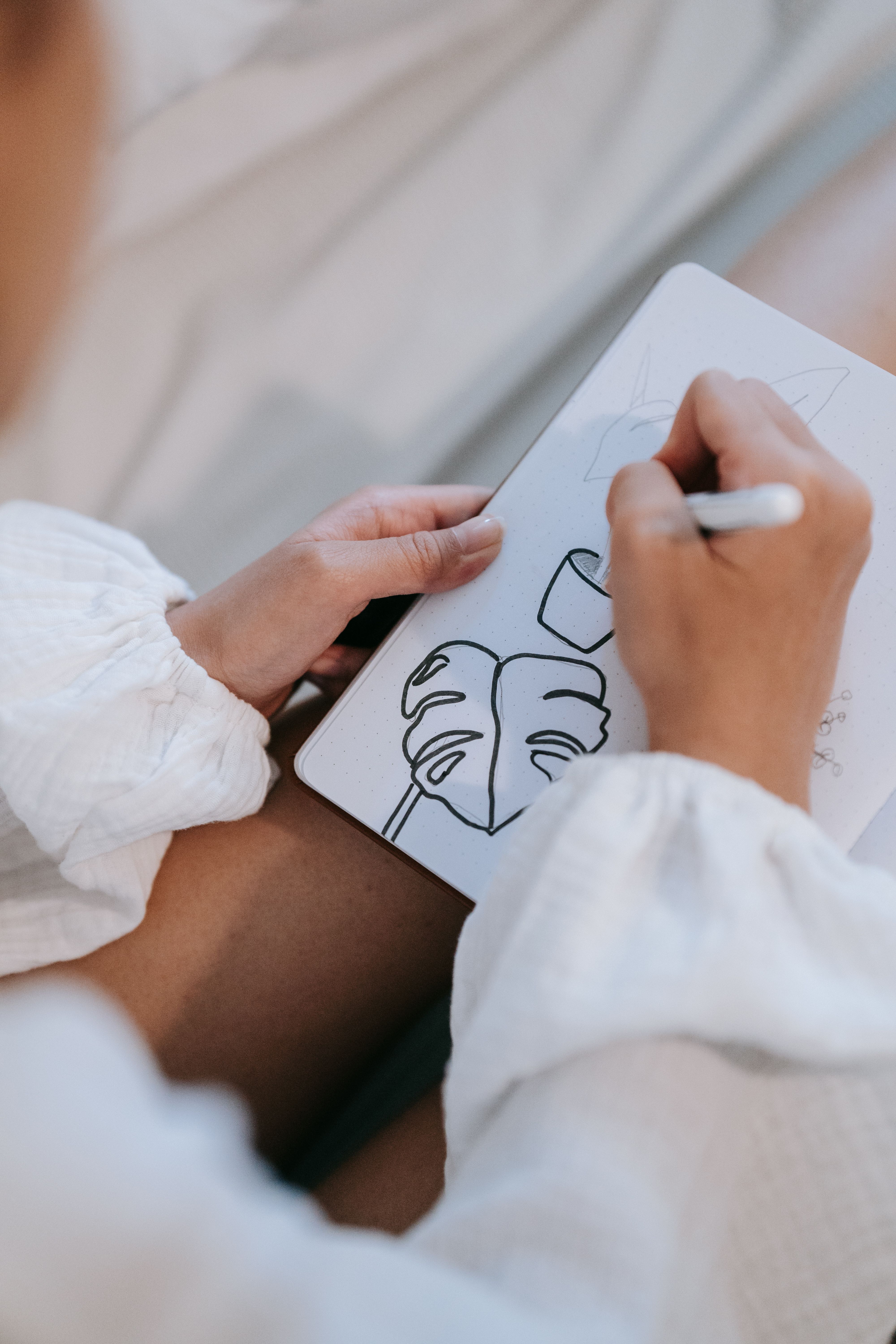 Close-Up Shot of Person Drawing on a Notebook · Free Stock Photo