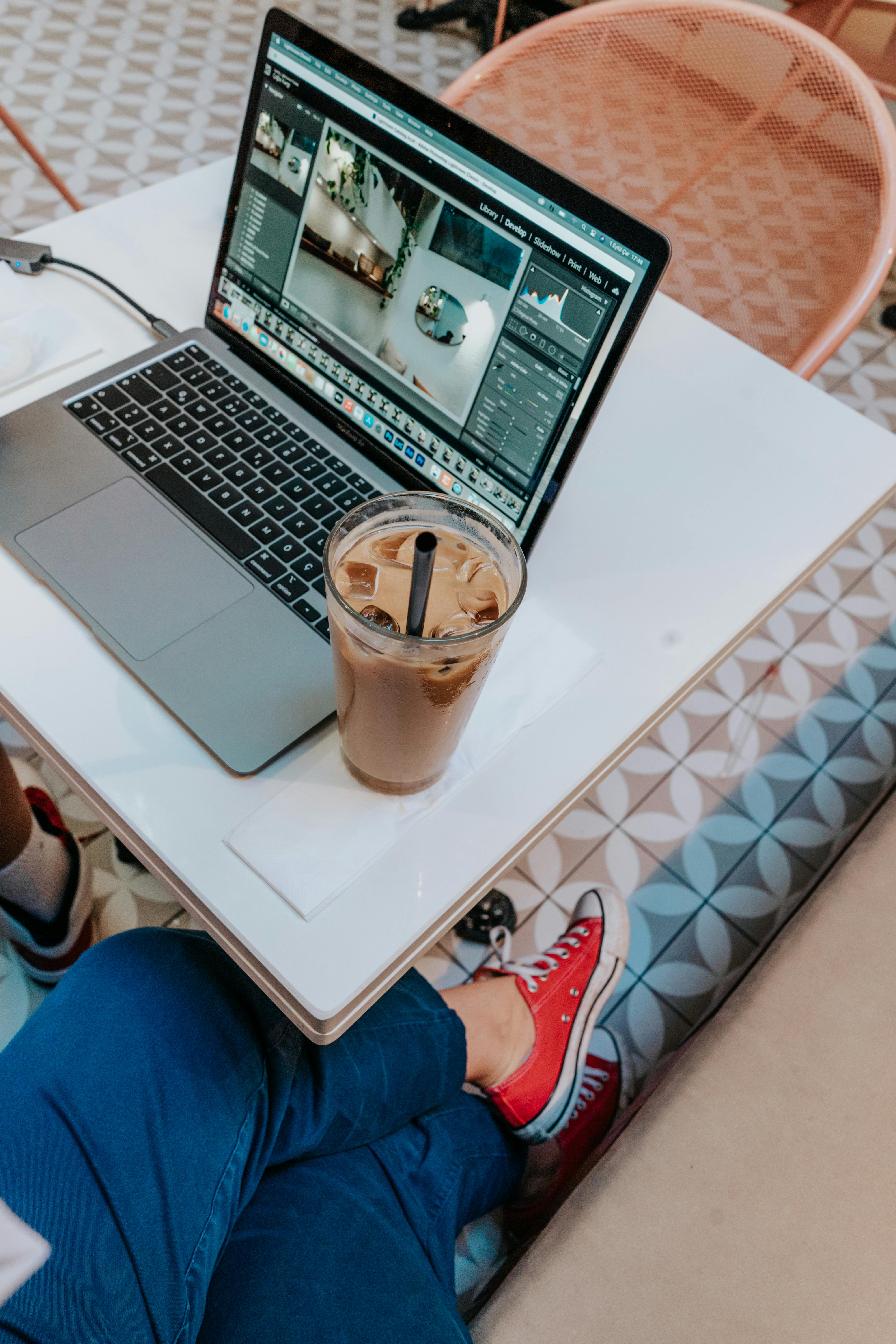 Laptop on a Table in a Coffee Shop · Free Stock Photo