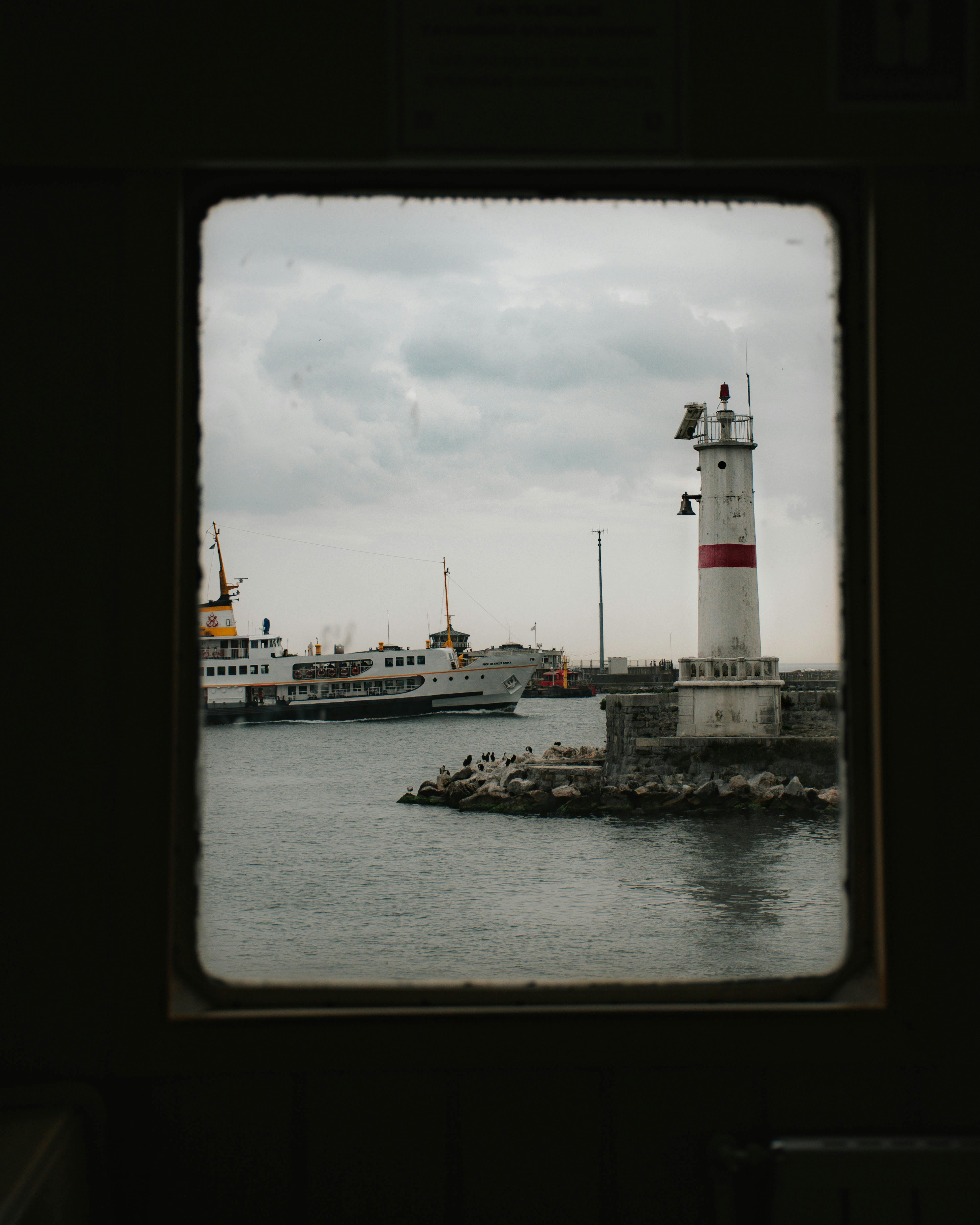A Lighthouse Viewed from a Glass Window · Free Stock Photo