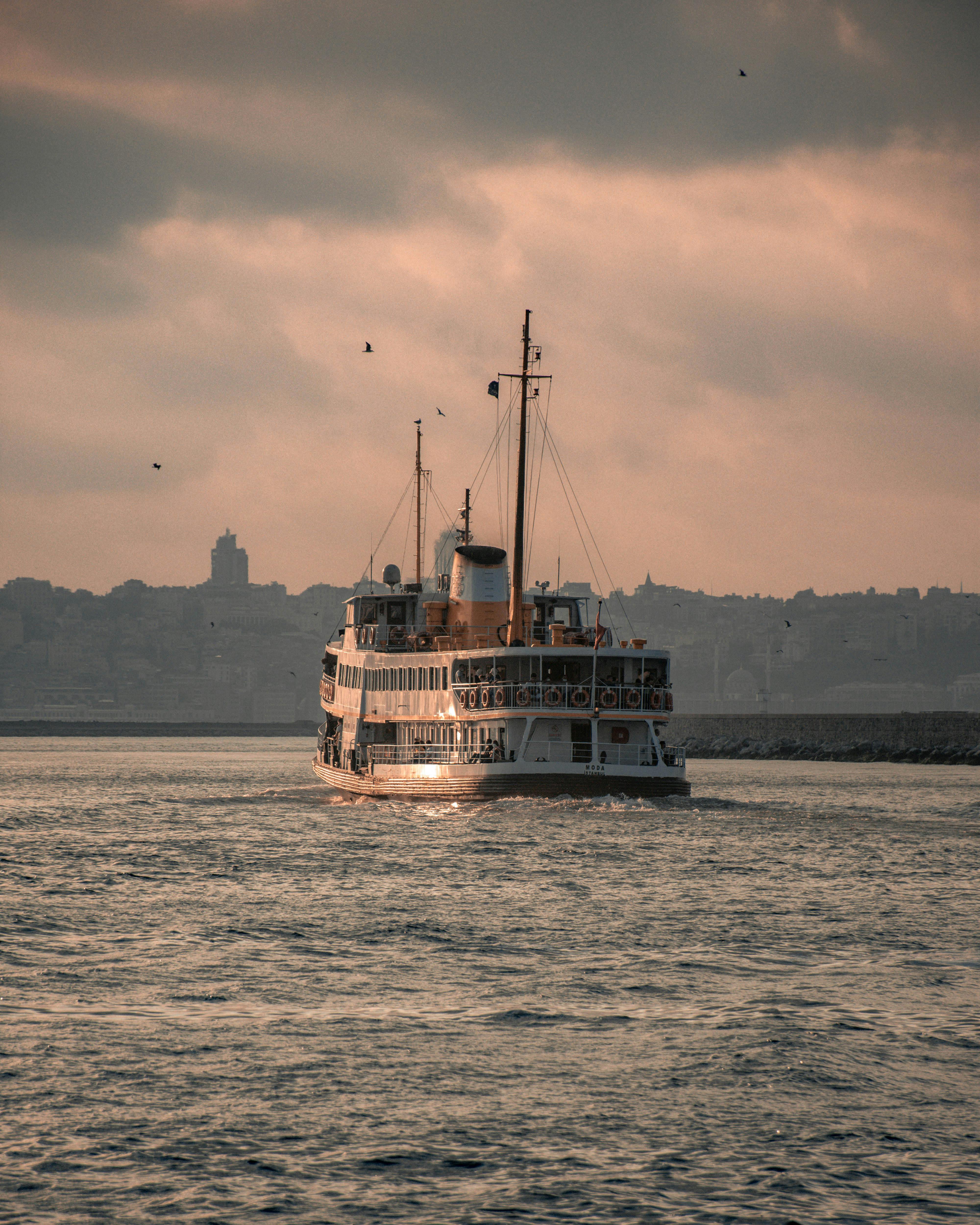A Ferry Ship Sailing in the Ocean During Golden Hour · Free Stock Photo