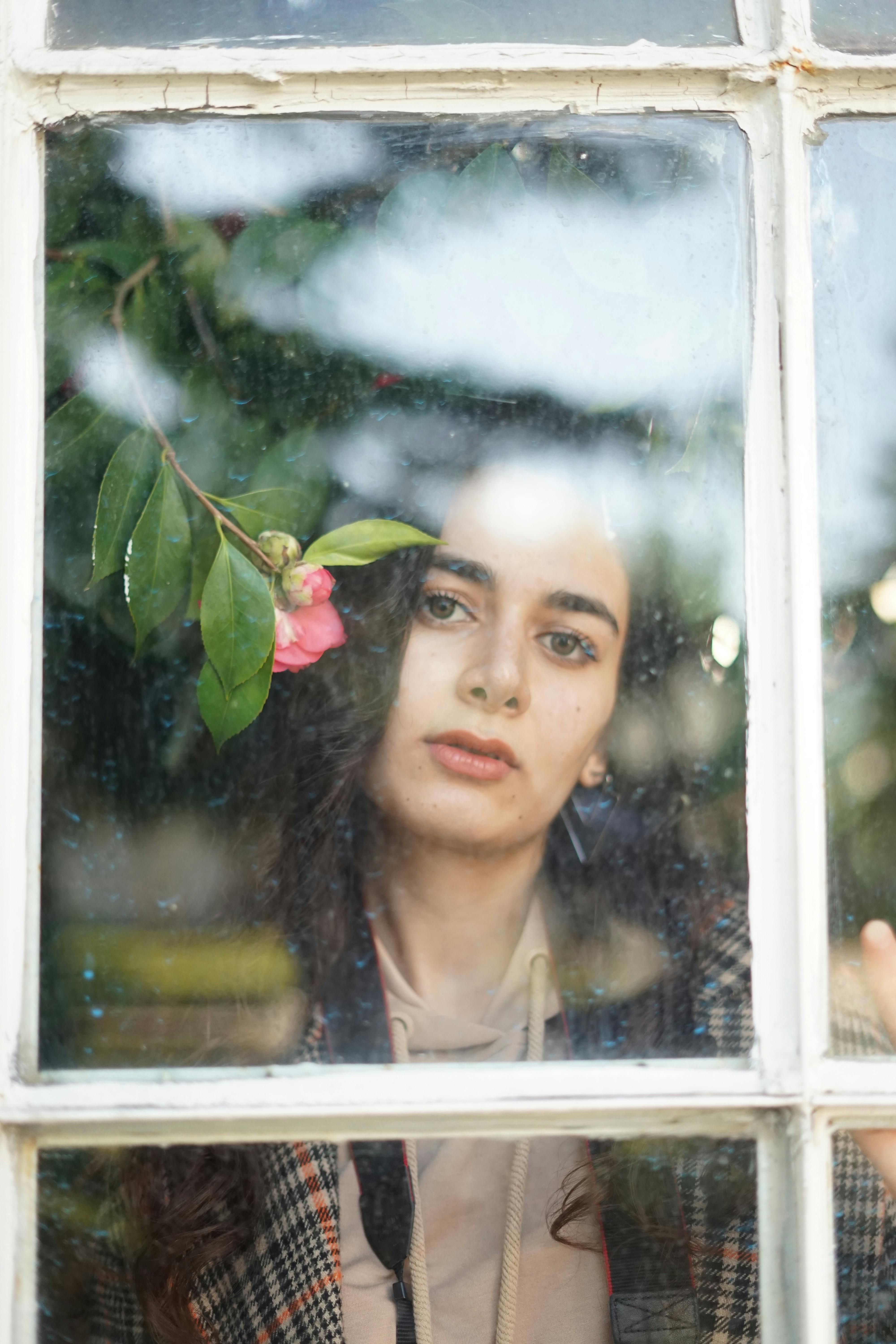Beautiful Woman behind a Glass Window · Free Stock Photo