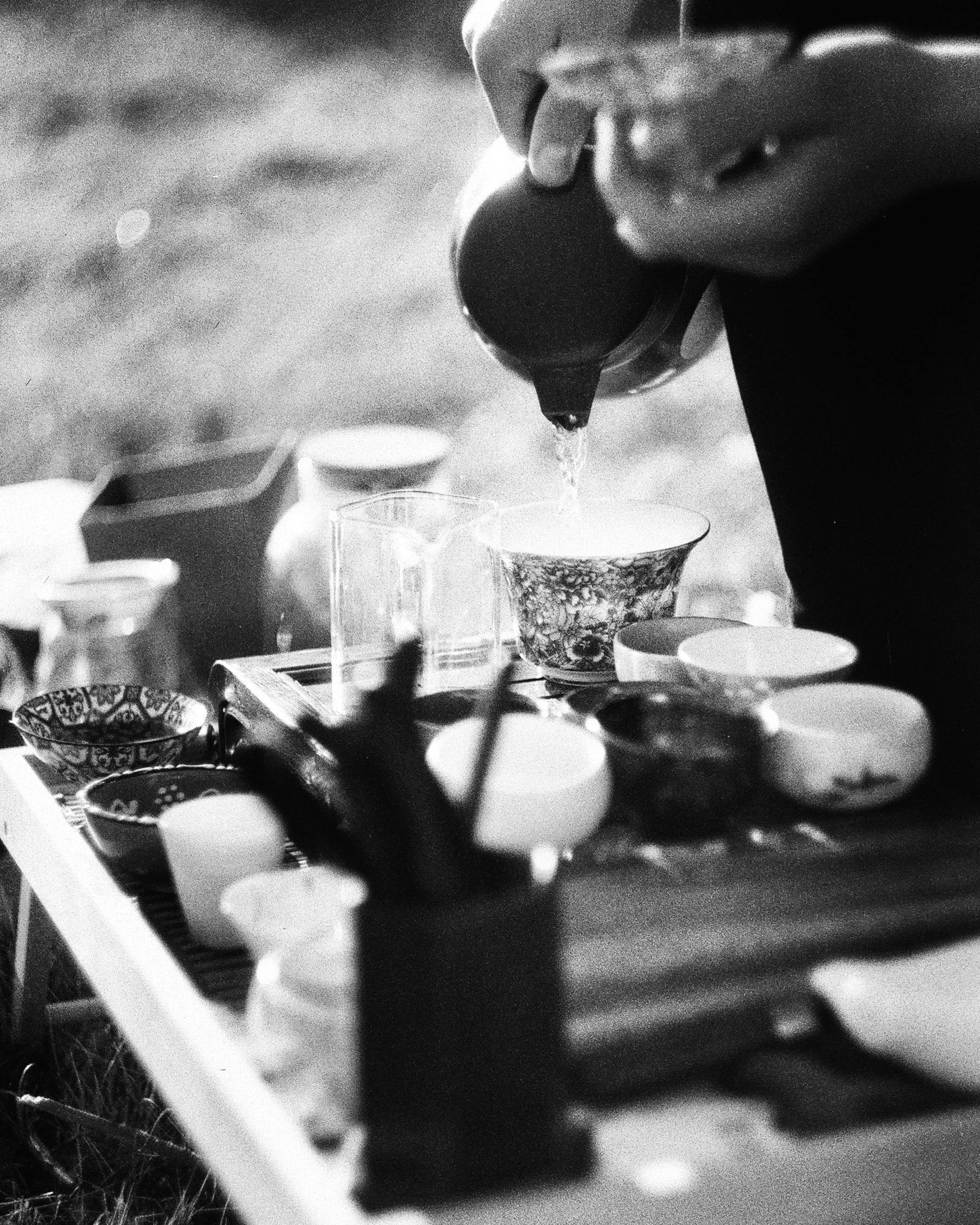 Grayscale Photo of a Person Pouring Water on a Cup · Free Stock Photo