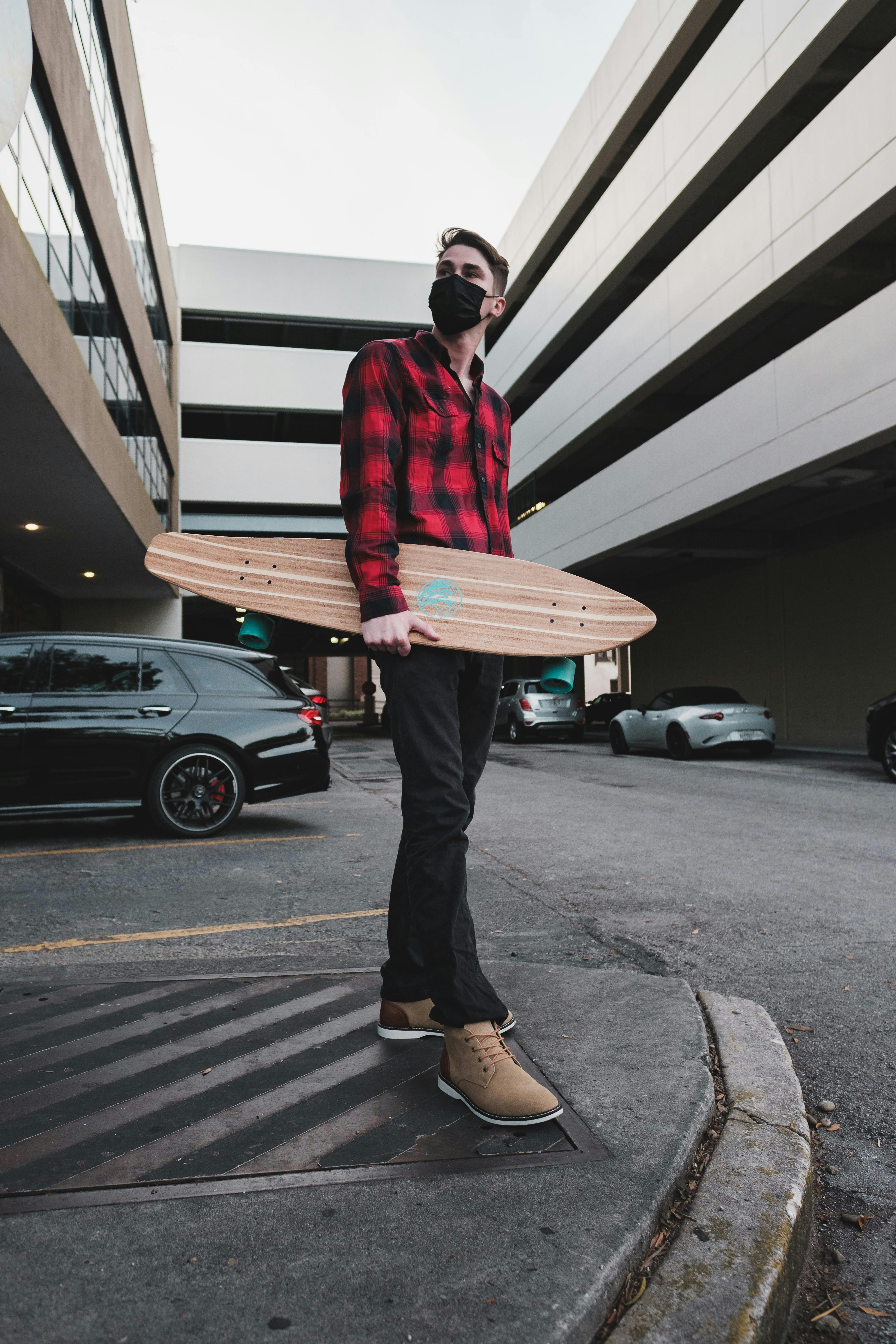 A Man Carrying Longboard · Free Stock Photo
