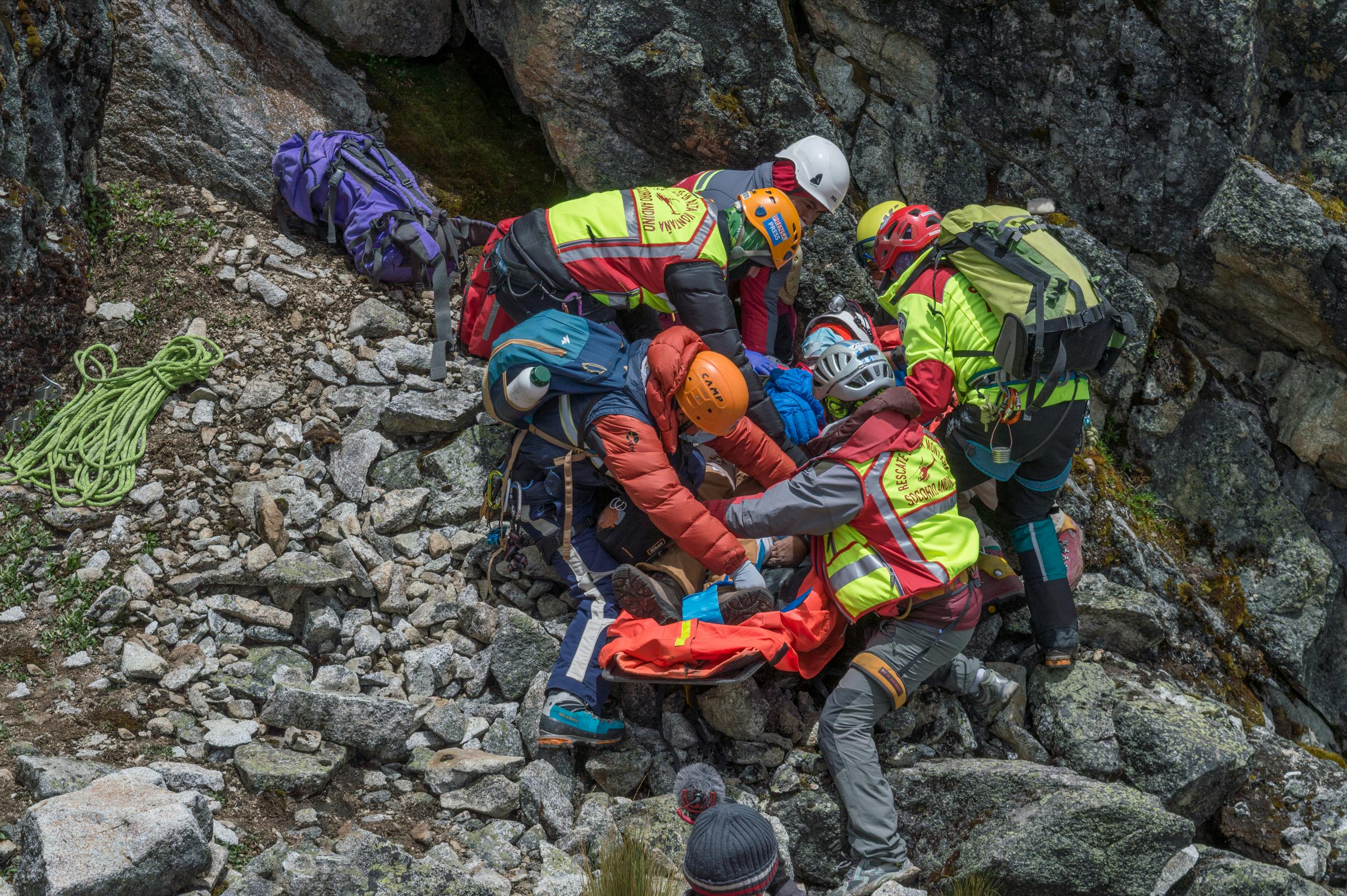 Group of Rescue Men Saving an Injured Person on Rocky Mountainside ...