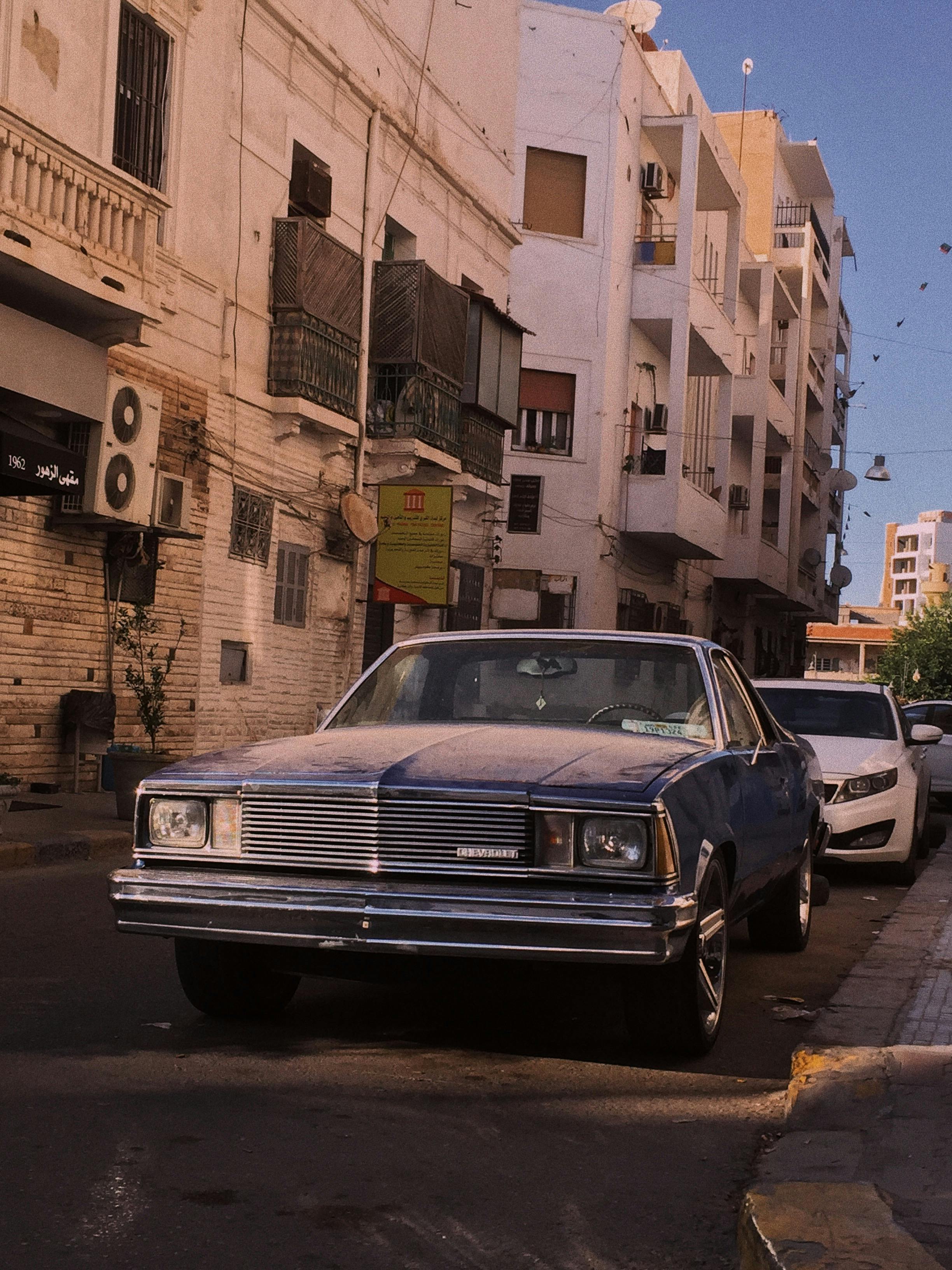 Photo of a Road with Vehicles Near Buildings · Free Stock Photo
