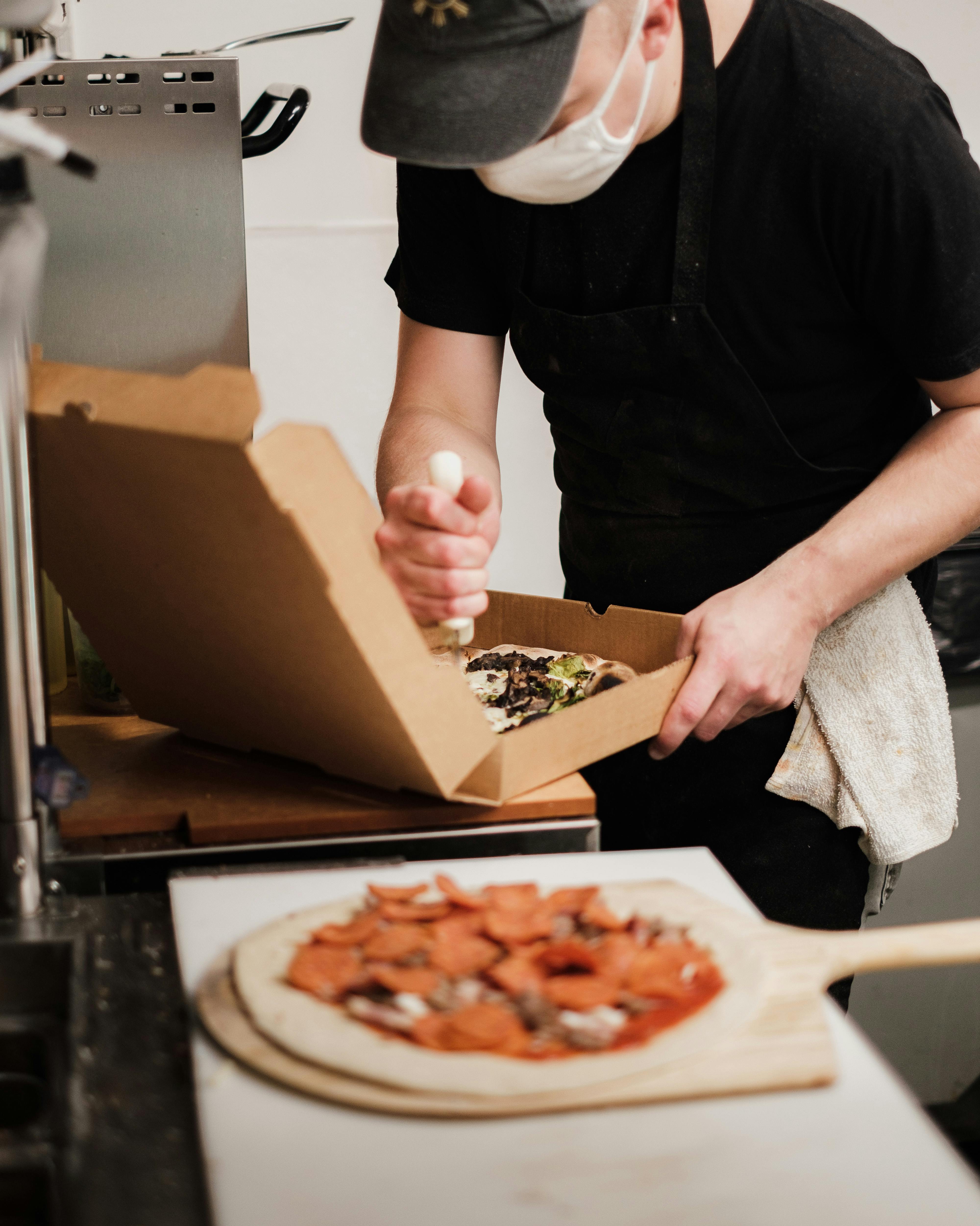 Close-up of Man Making Pizza · Free Stock Photo