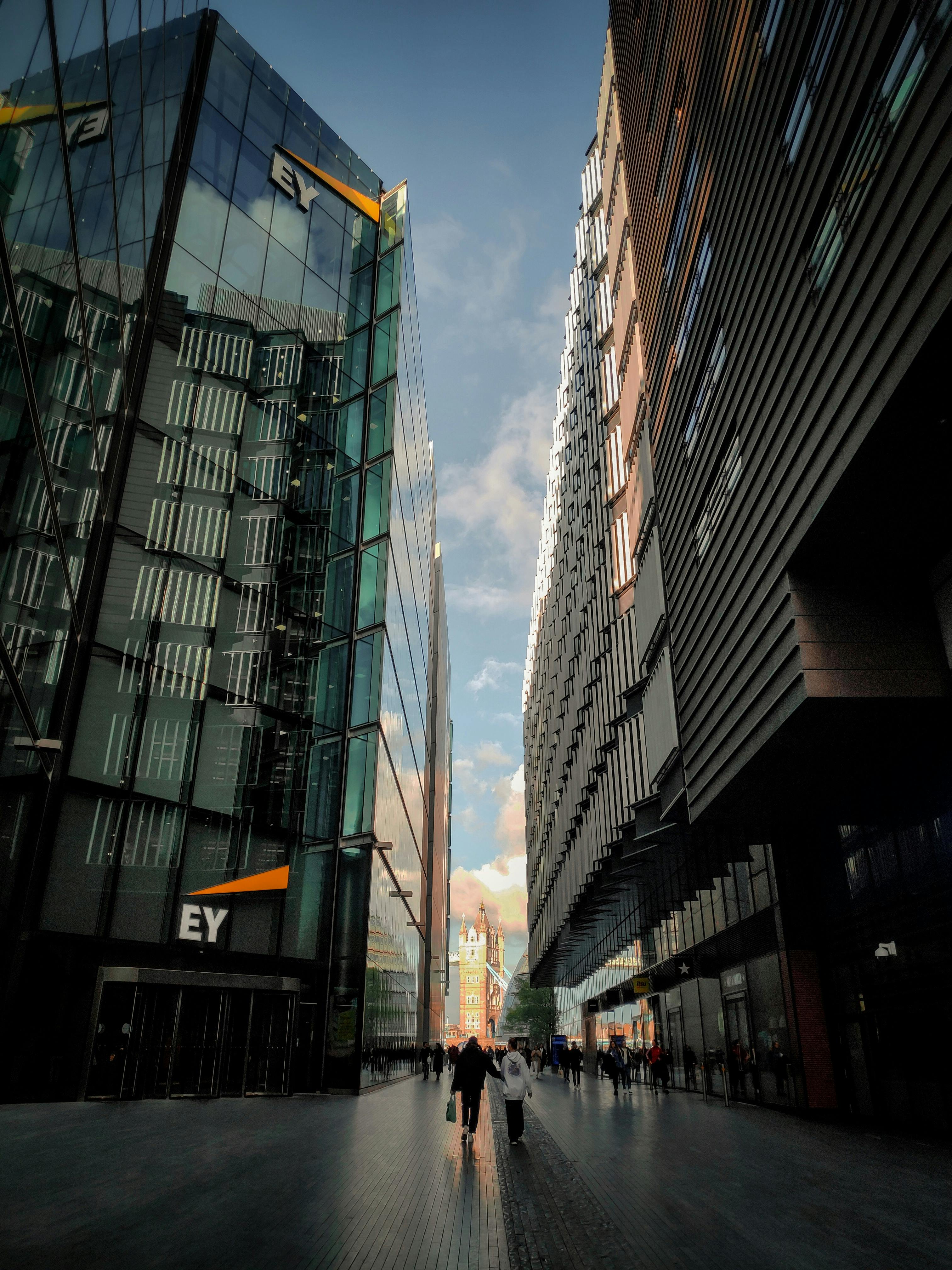People Walking on City Street between Buildings · Free Stock Photo
