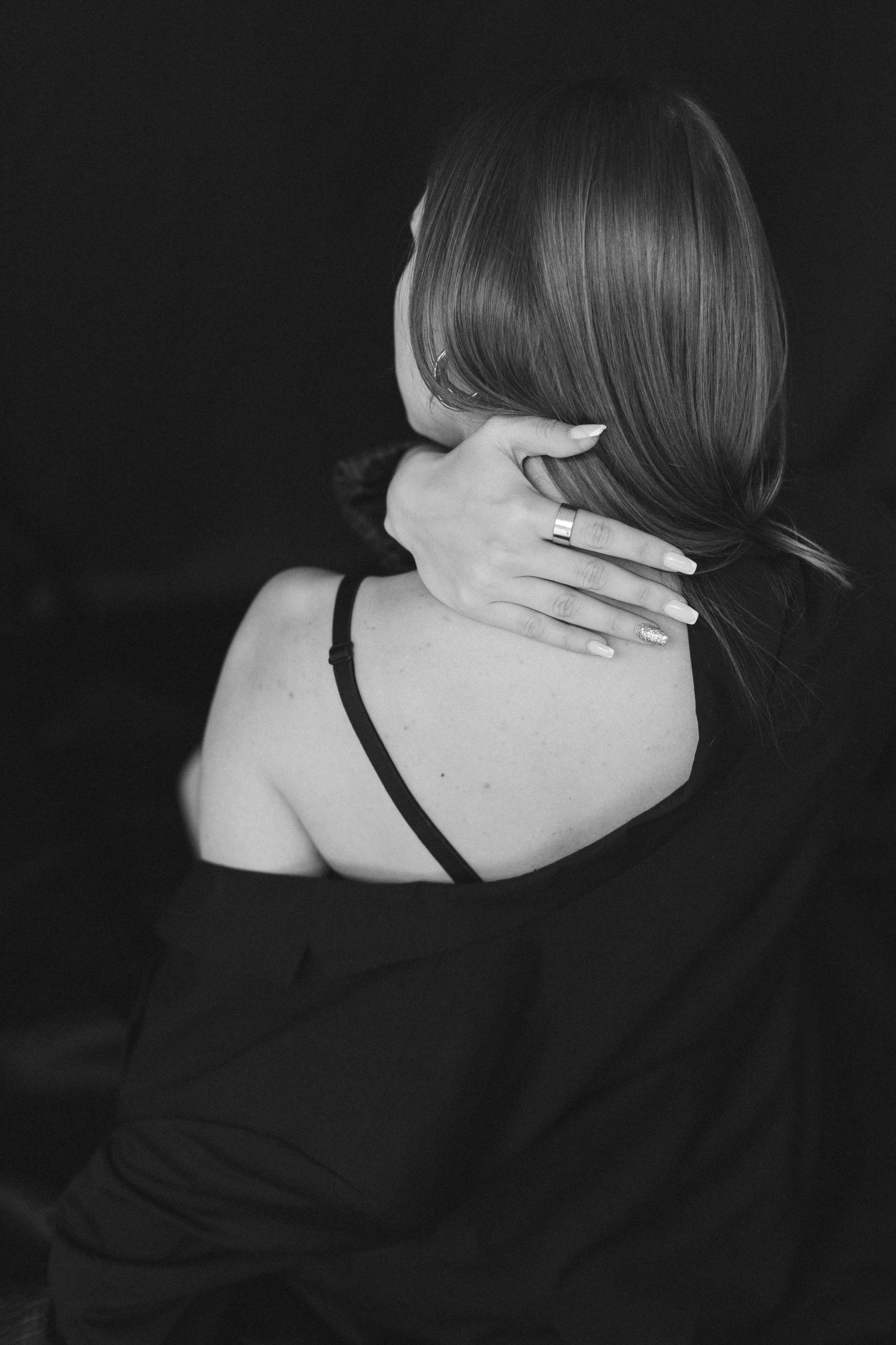 A Woman with Her Hand on Her Nape · Free Stock Photo