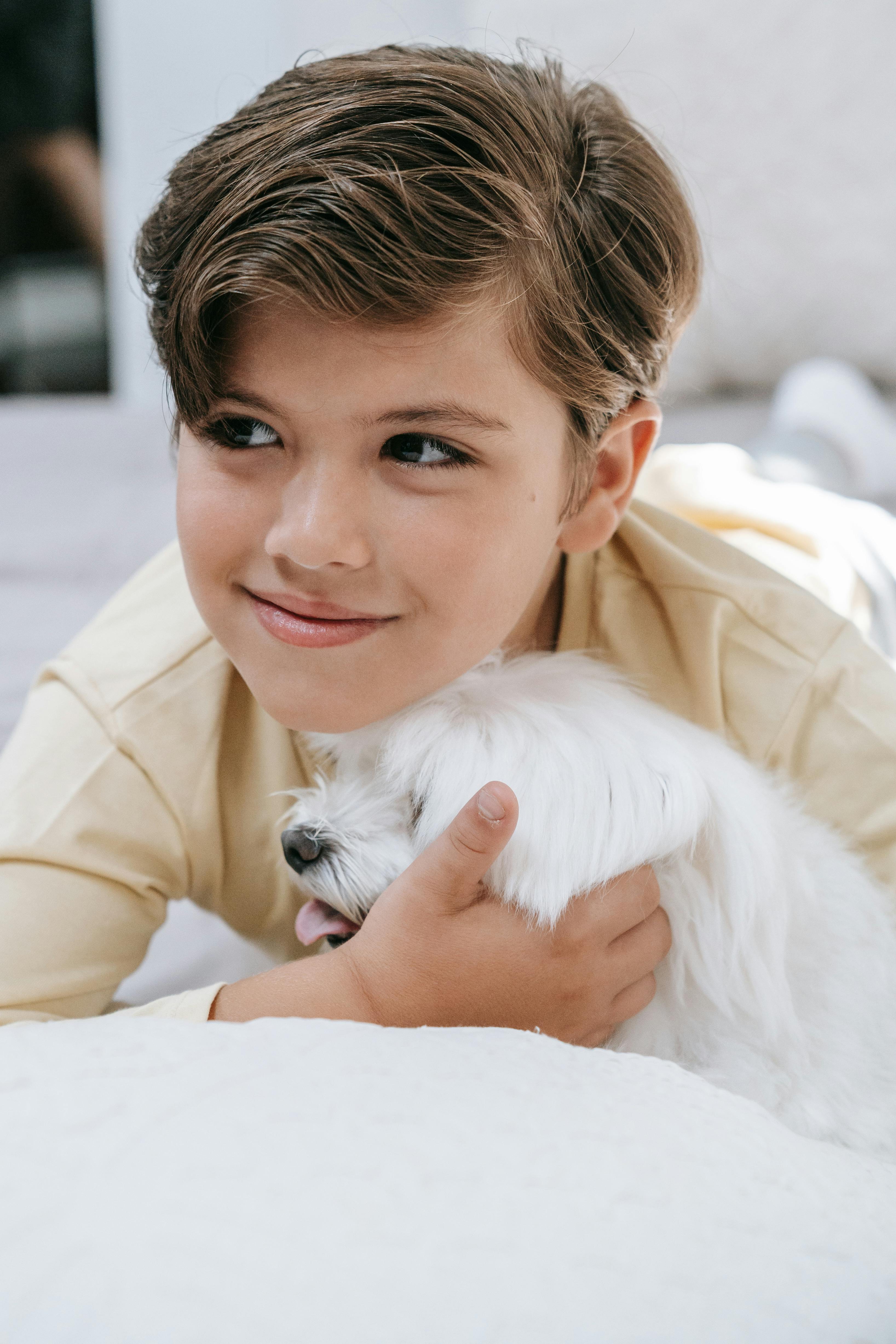 A Boy Cuddling with His Dog · Free Stock Photo