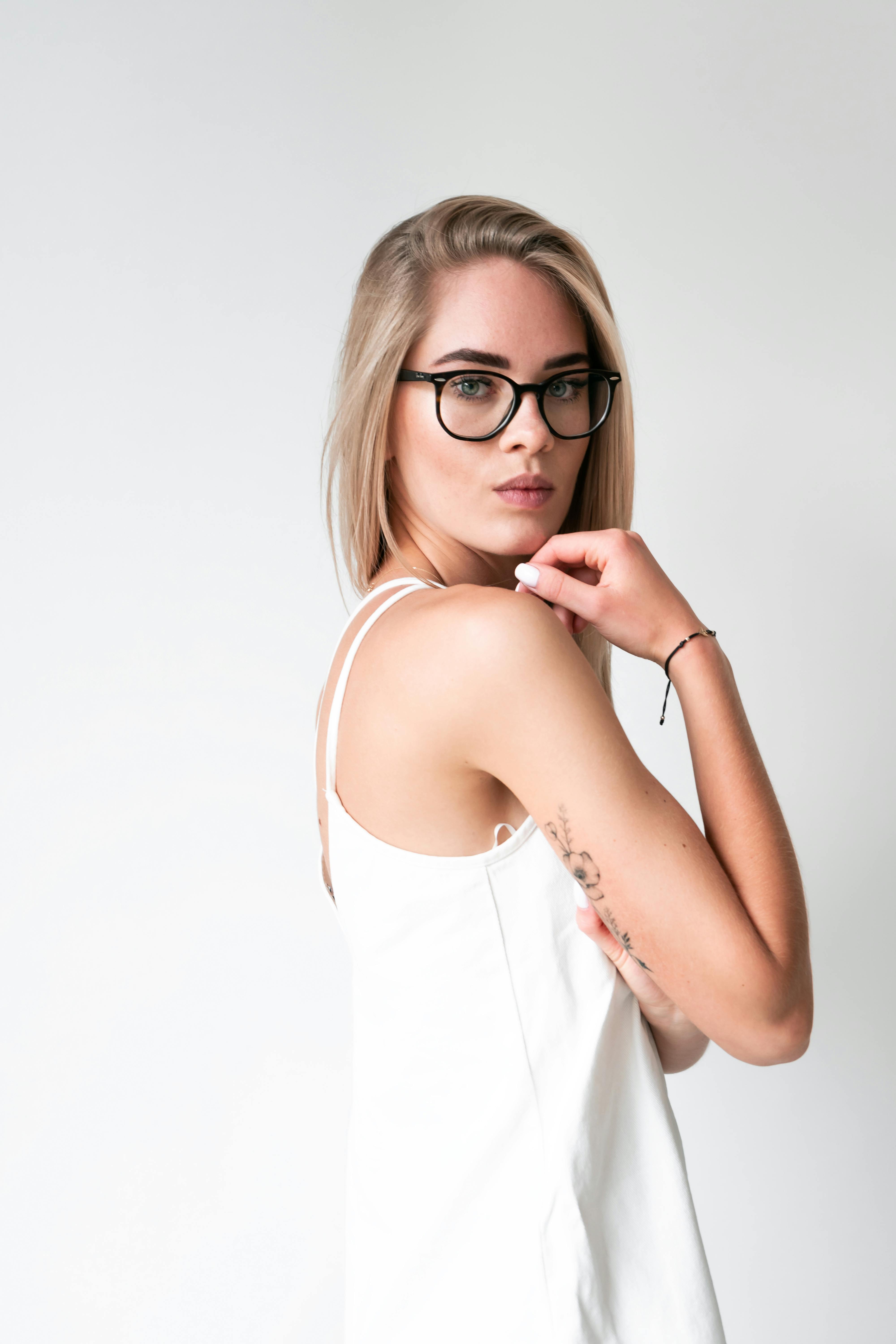 Woman Wearing a White Tank Top and Black Framed Eyeglasses · Free Stock ...