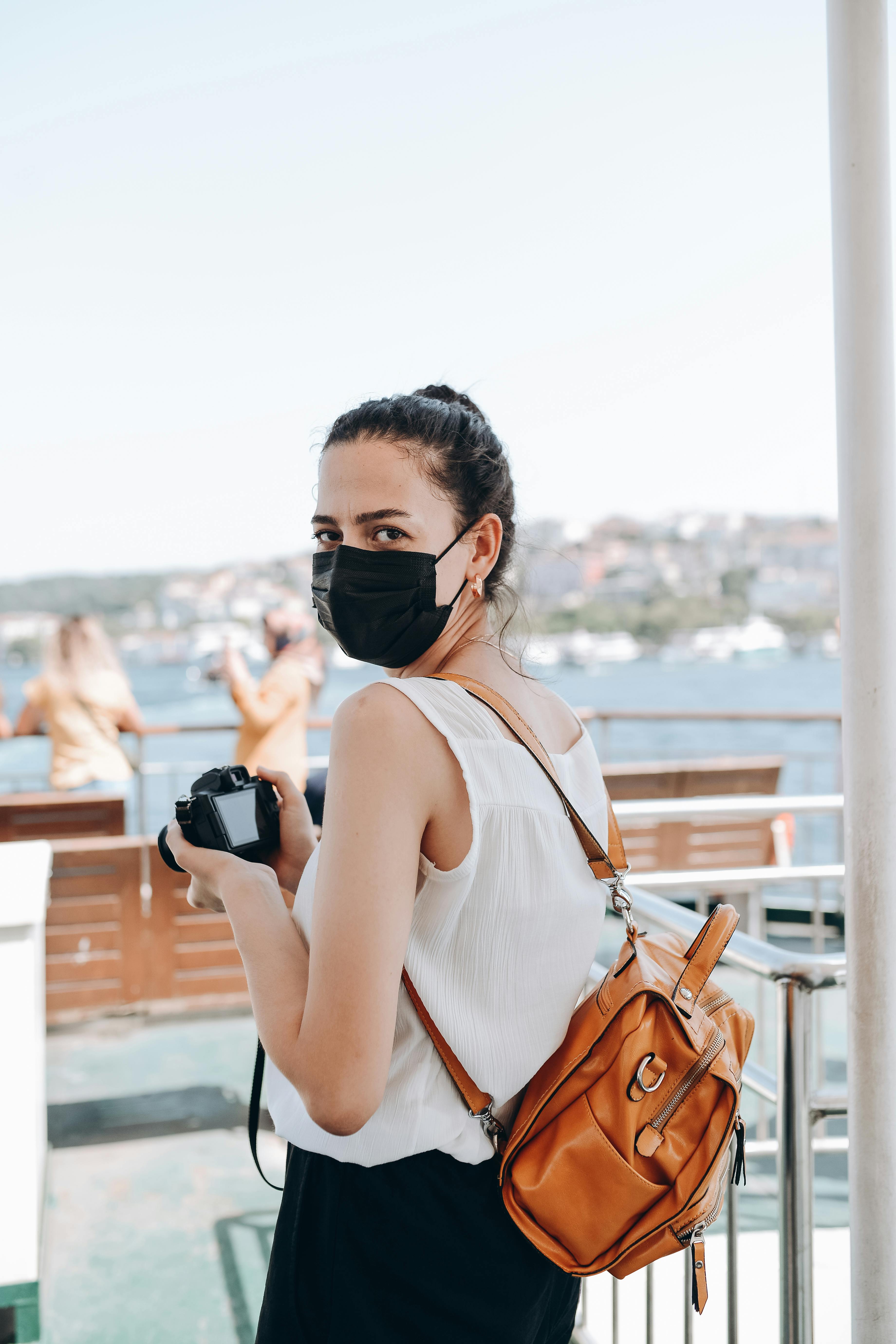 Woman in Black Jacket Holding a Garbage Bag · Free Stock Photo