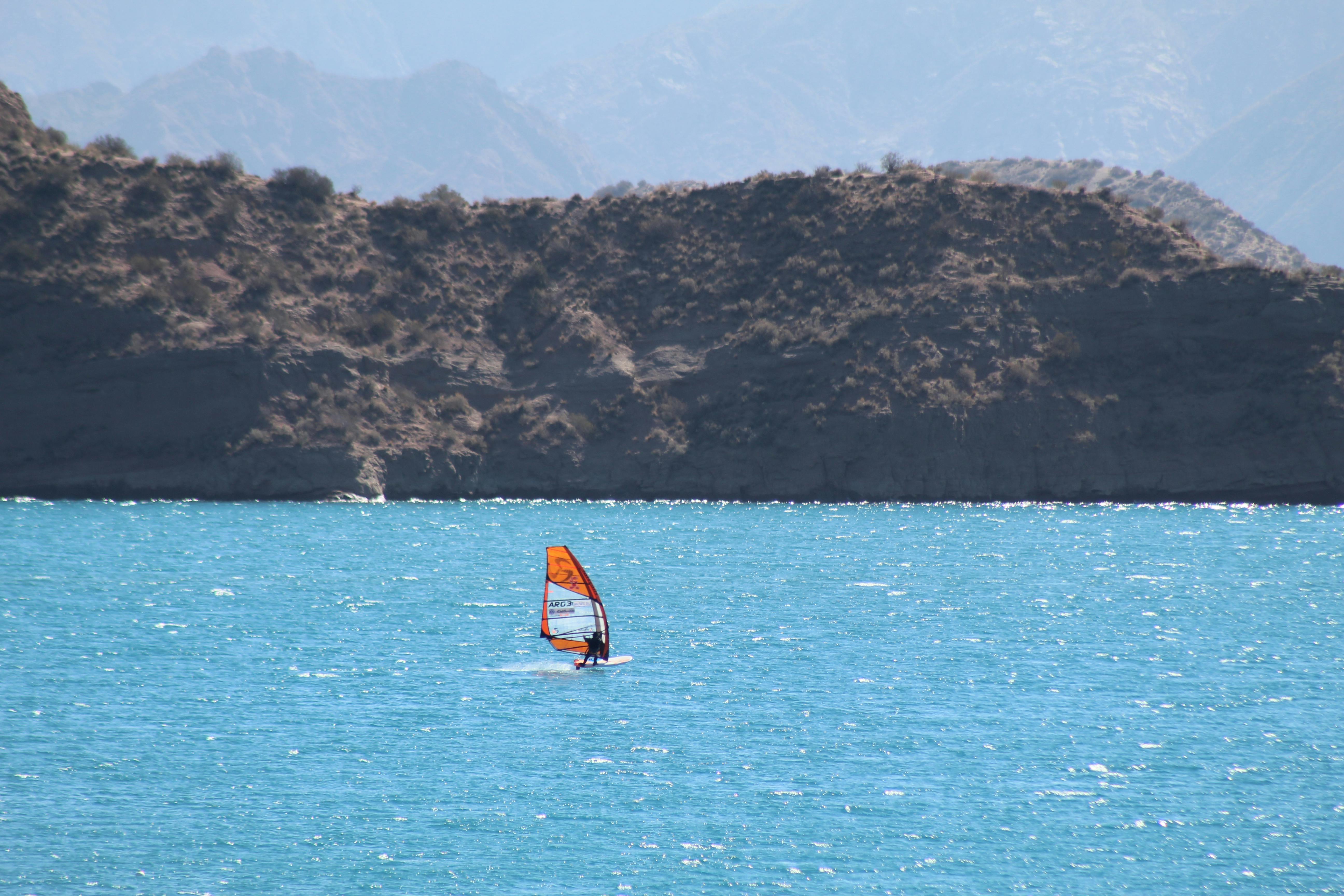 Person Riding a Sailboat on Body of Water · Free Stock Photo