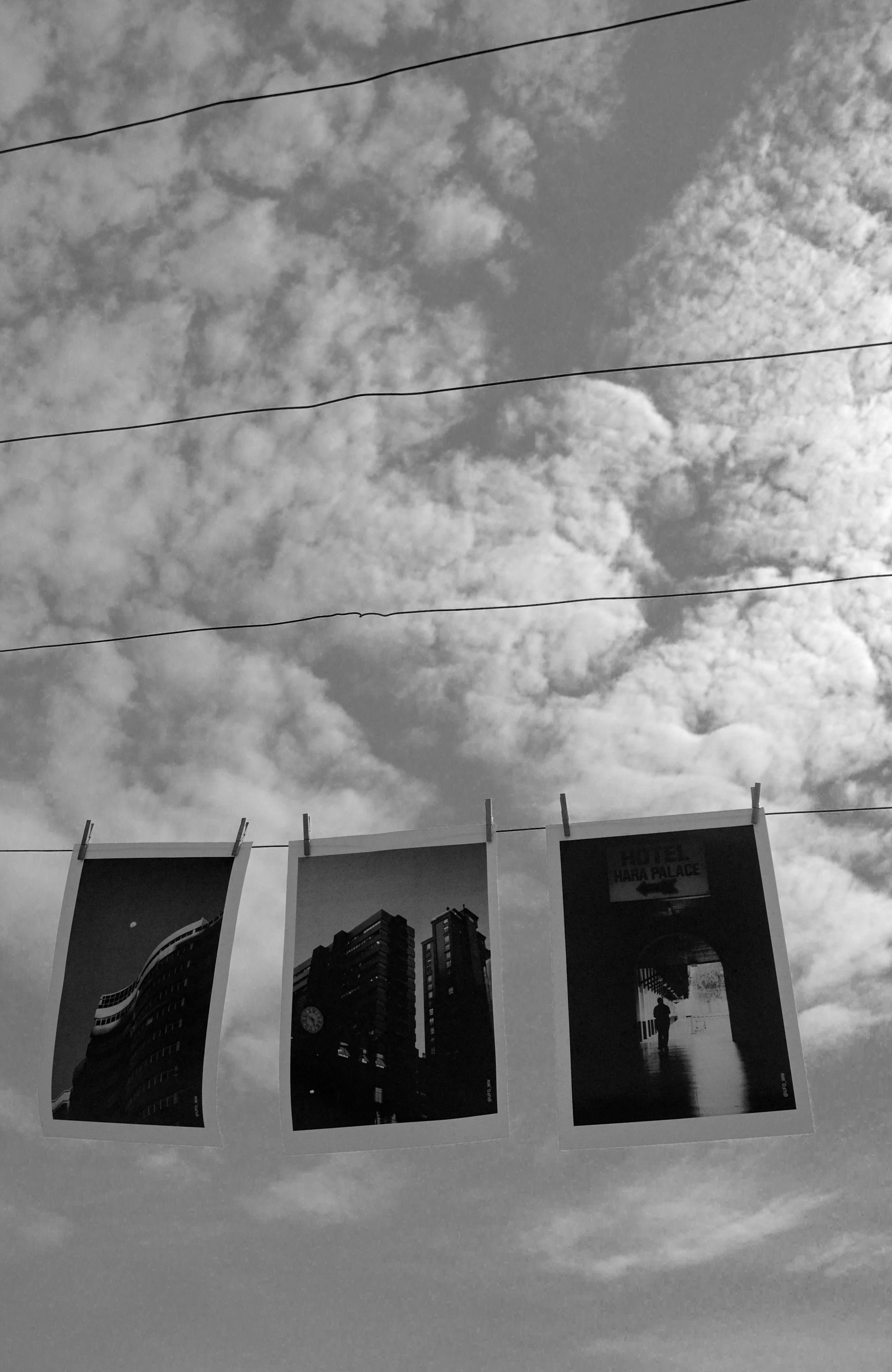 Grayscale of Pictures Hand with View of the Clouds · Free Stock Photo