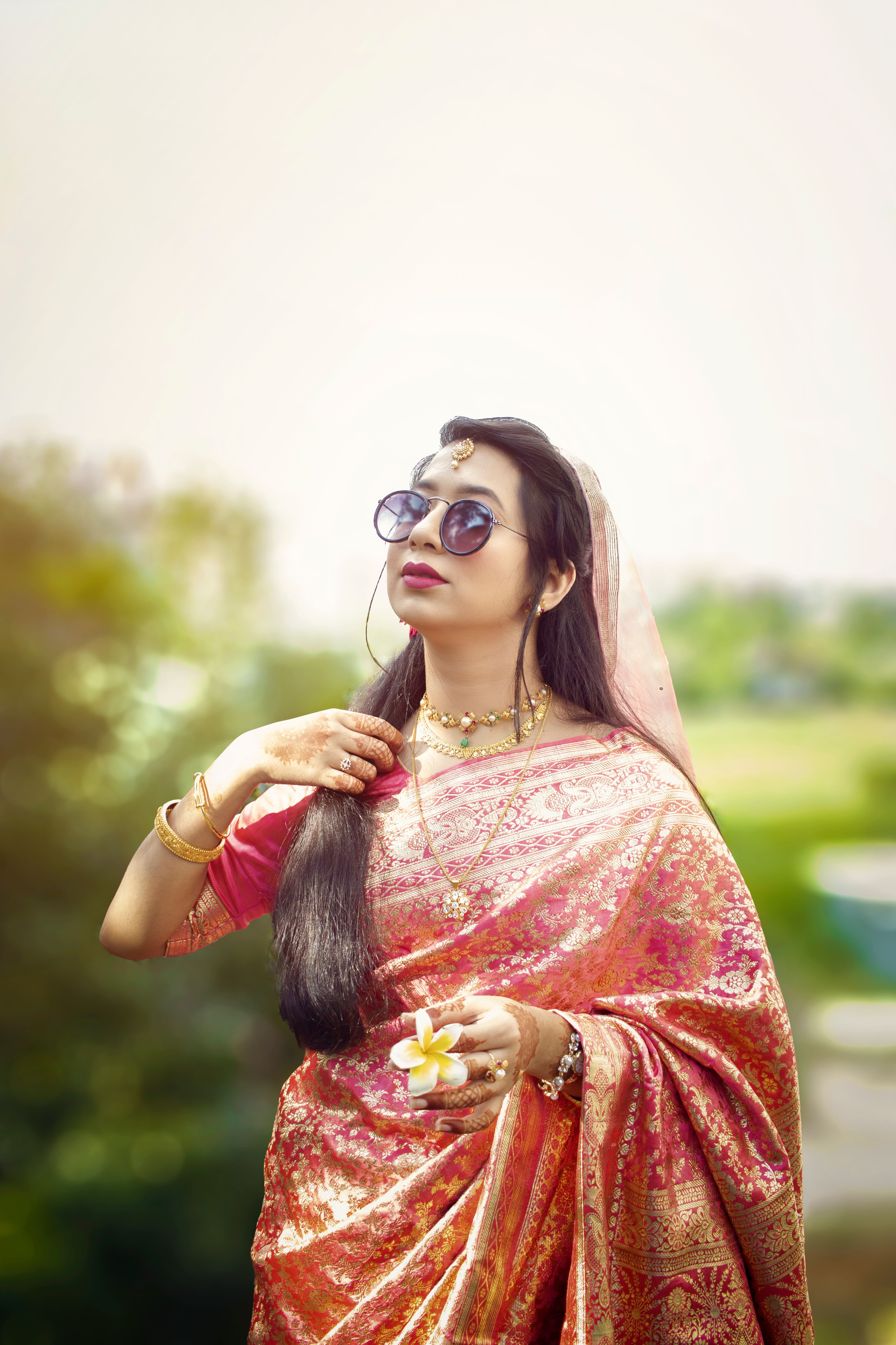 Unwrapped Sari Flying behind Woman Standing on Bridge · Free Stock Photo