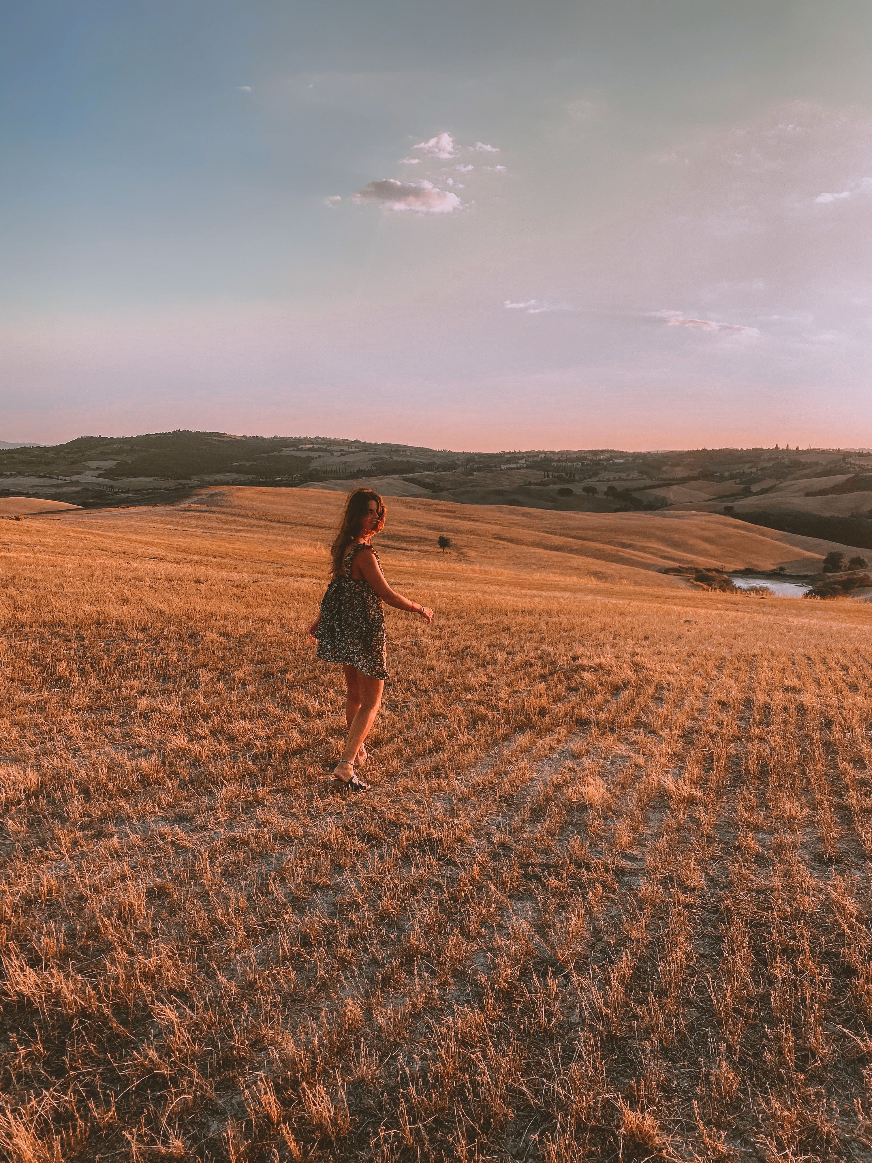Photo of a Woman Walking in a Field · Free Stock Photo