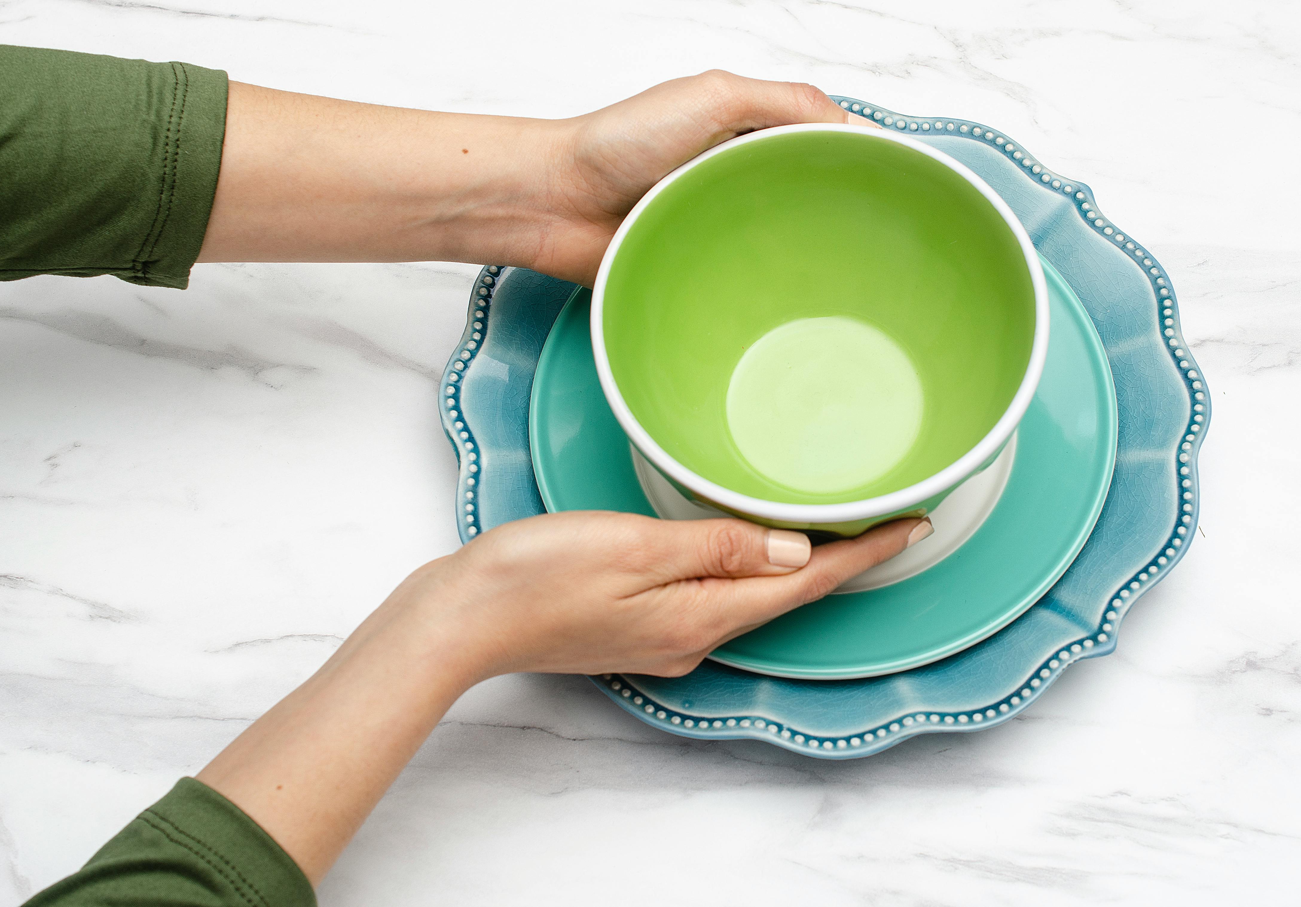 Putting White Plates on a Table · Free Stock Photo