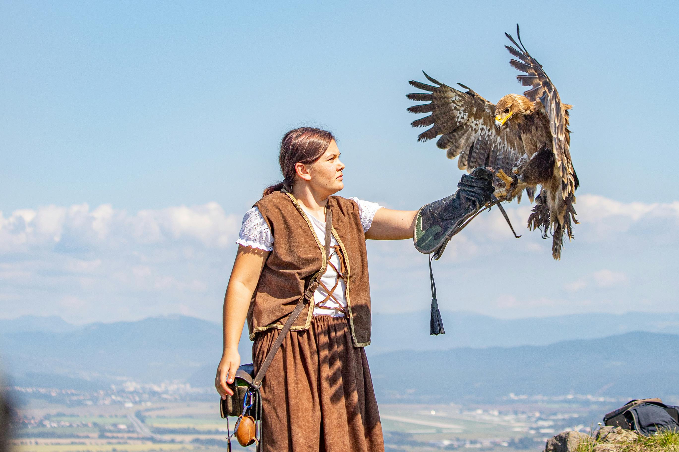 Woman in Brown Dress Holding Bird · Free Stock Photo