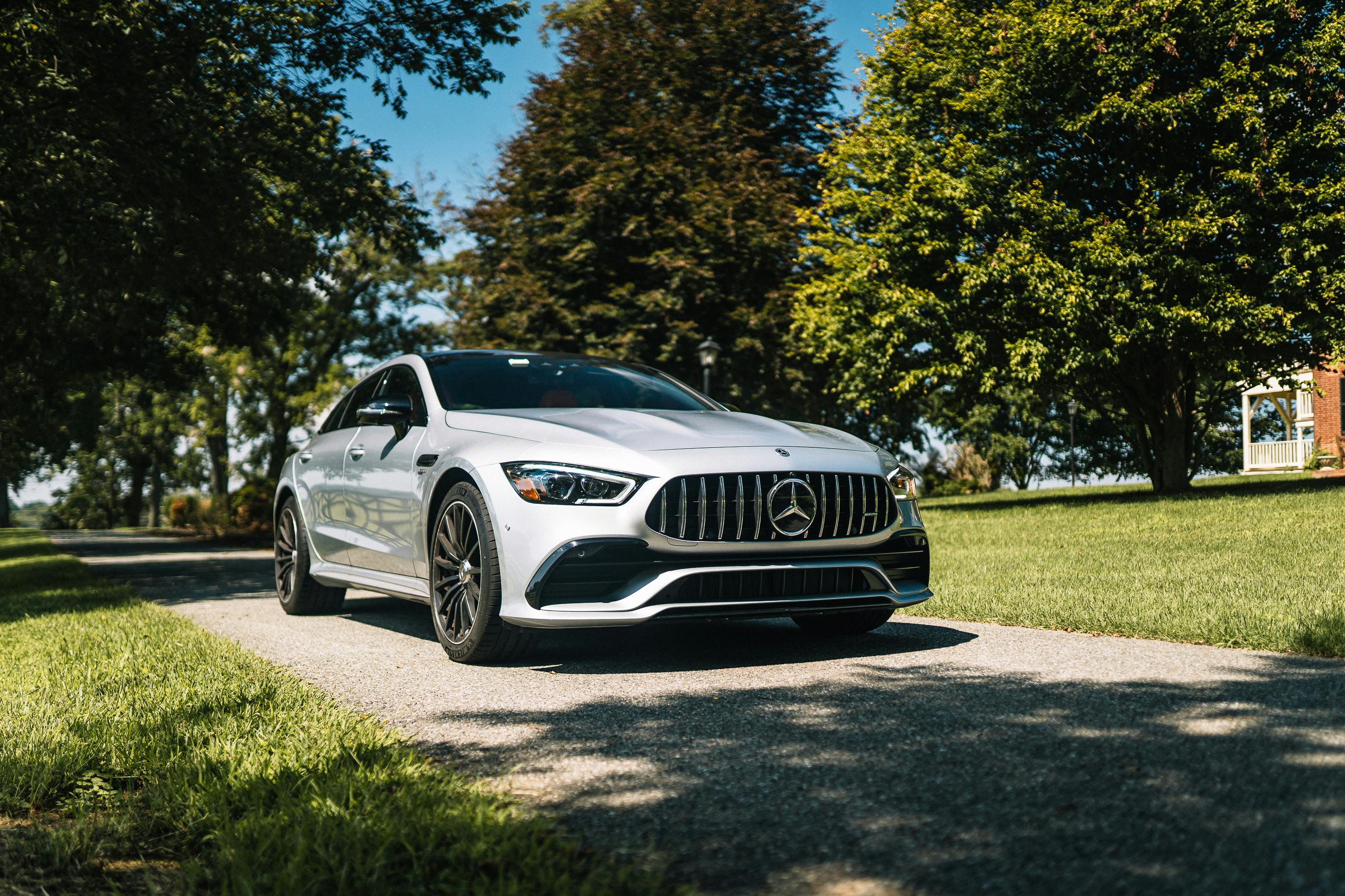 Modern Coupe Car on Road in Park · Free Stock Photo