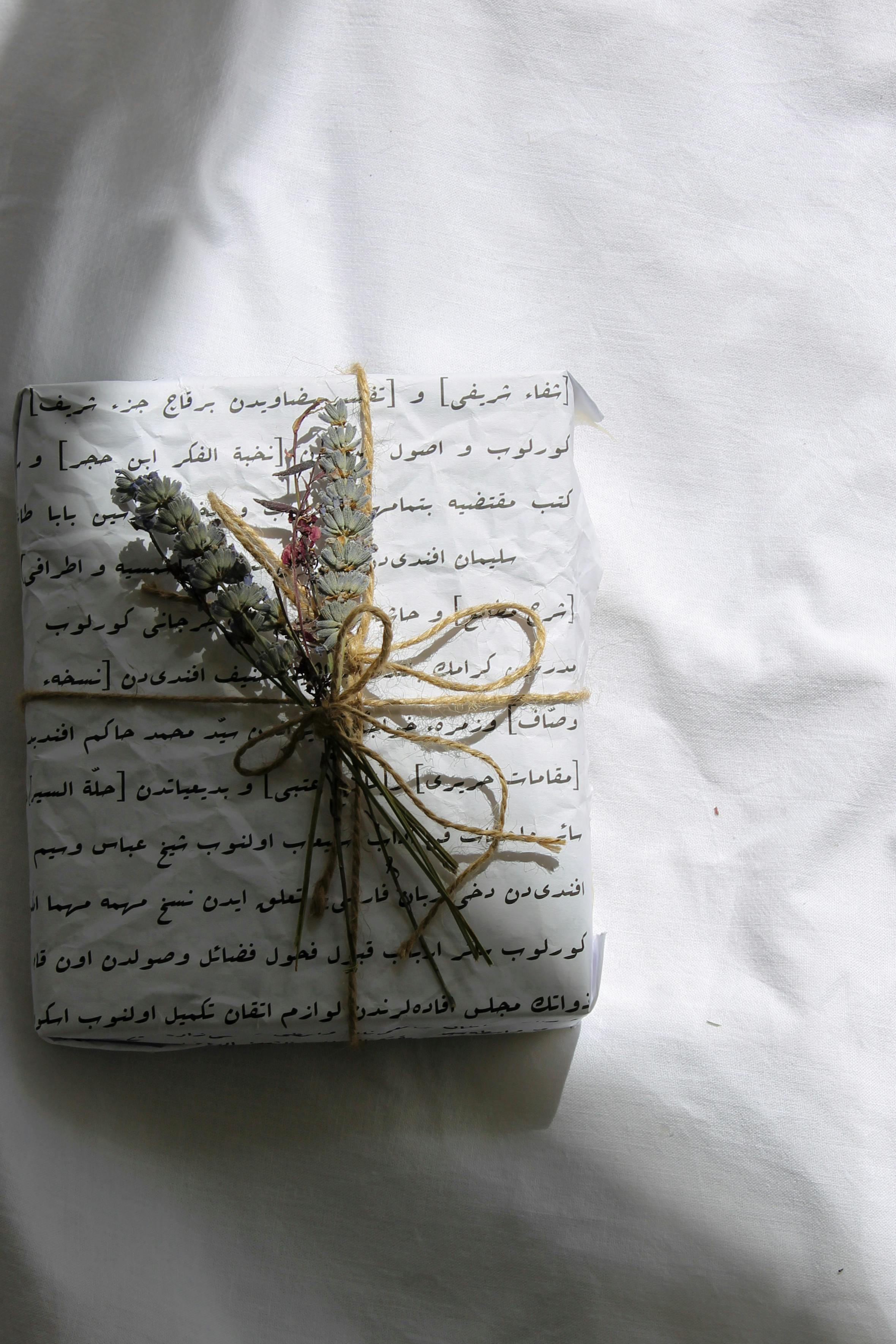 A Holiday Gift Wrapped with Brown Strings · Free Stock Photo