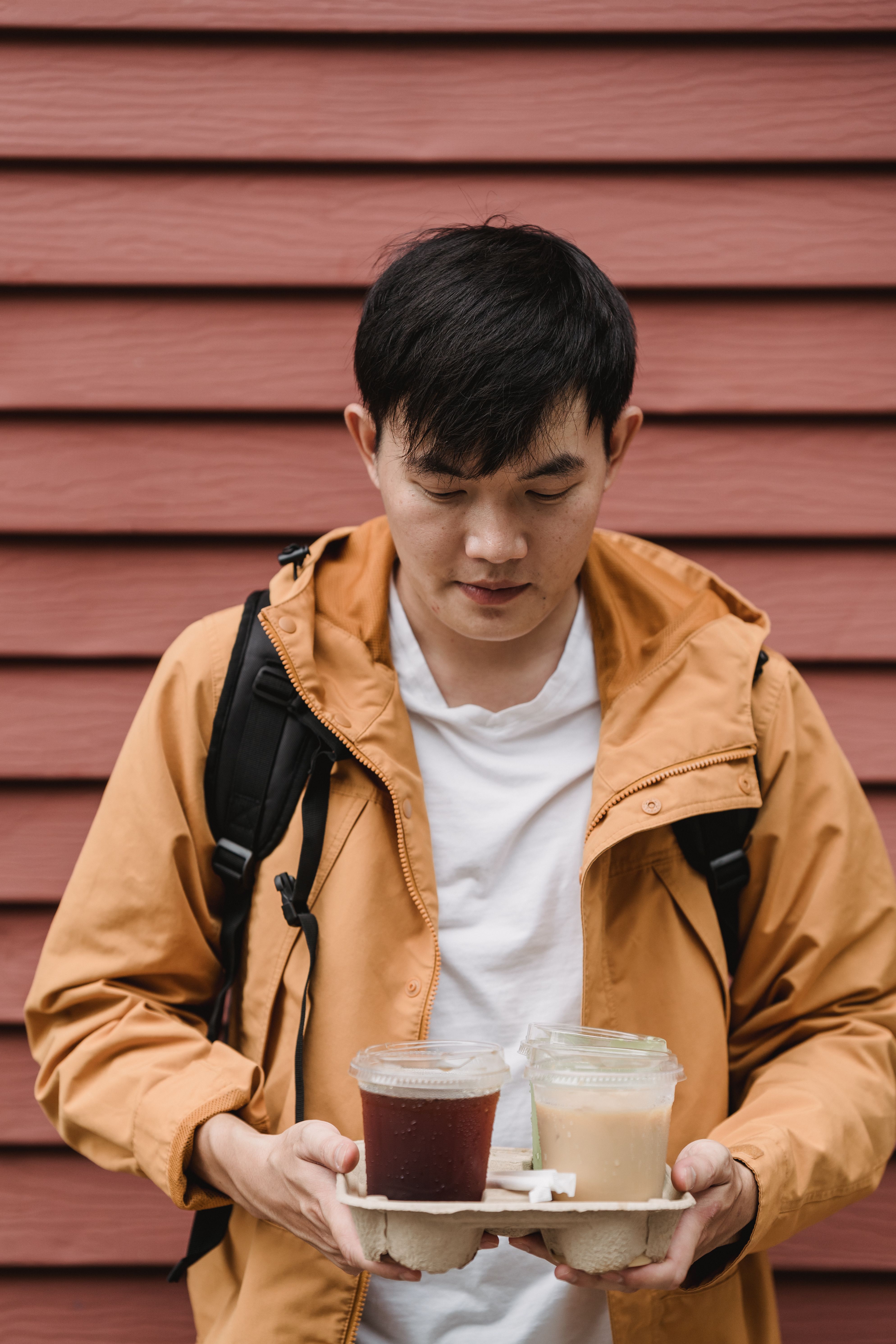 A Man Holding Cold Drinks in a Paper Tray · Free Stock Photo